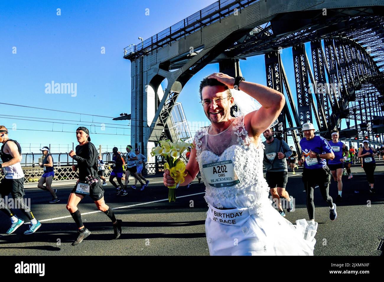 Runners are seen crossing the Sydney Harbour Bridge during the ...