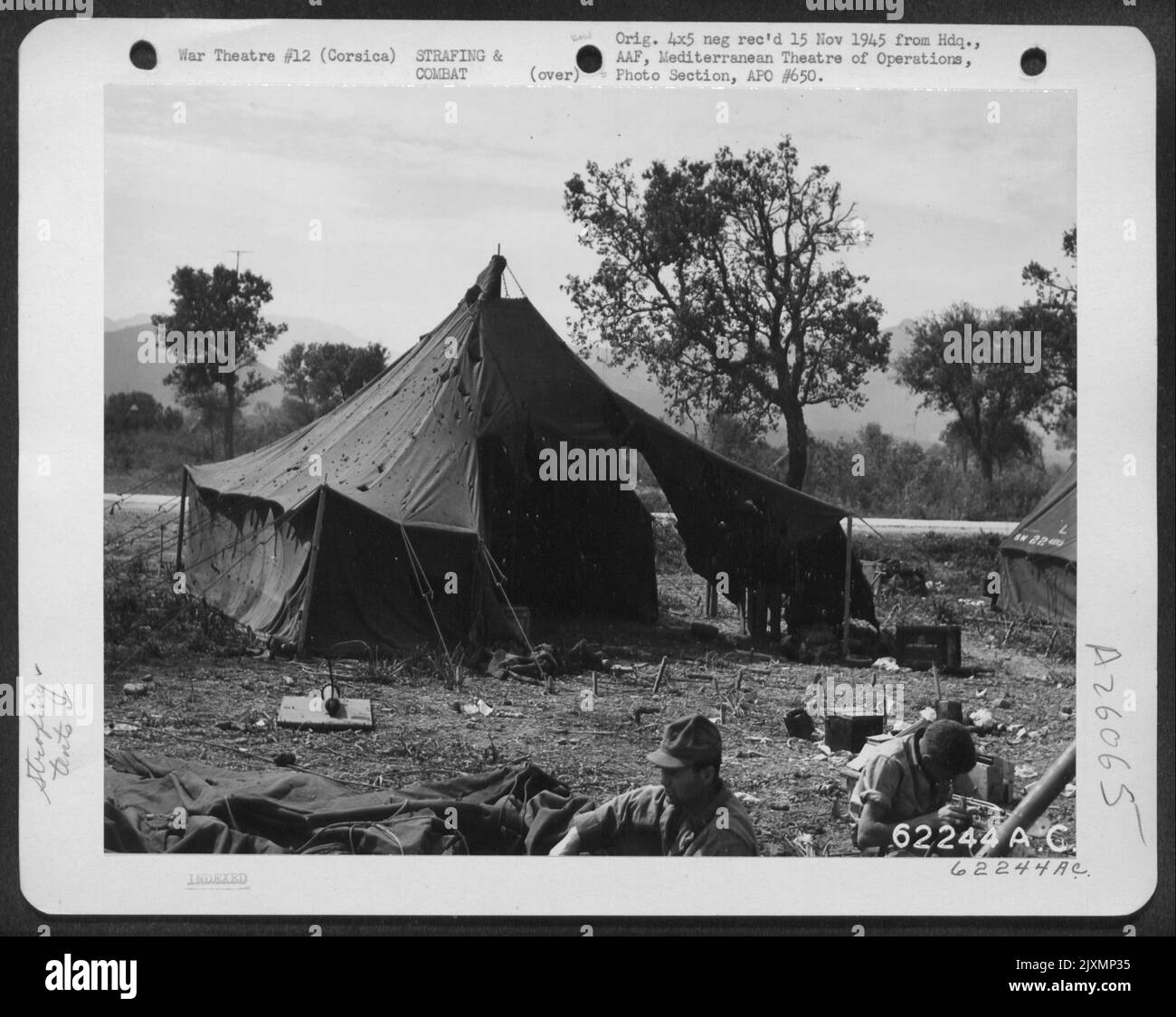 Allied tent at Corsican airfield bears resemblance to a sieve-result of ...