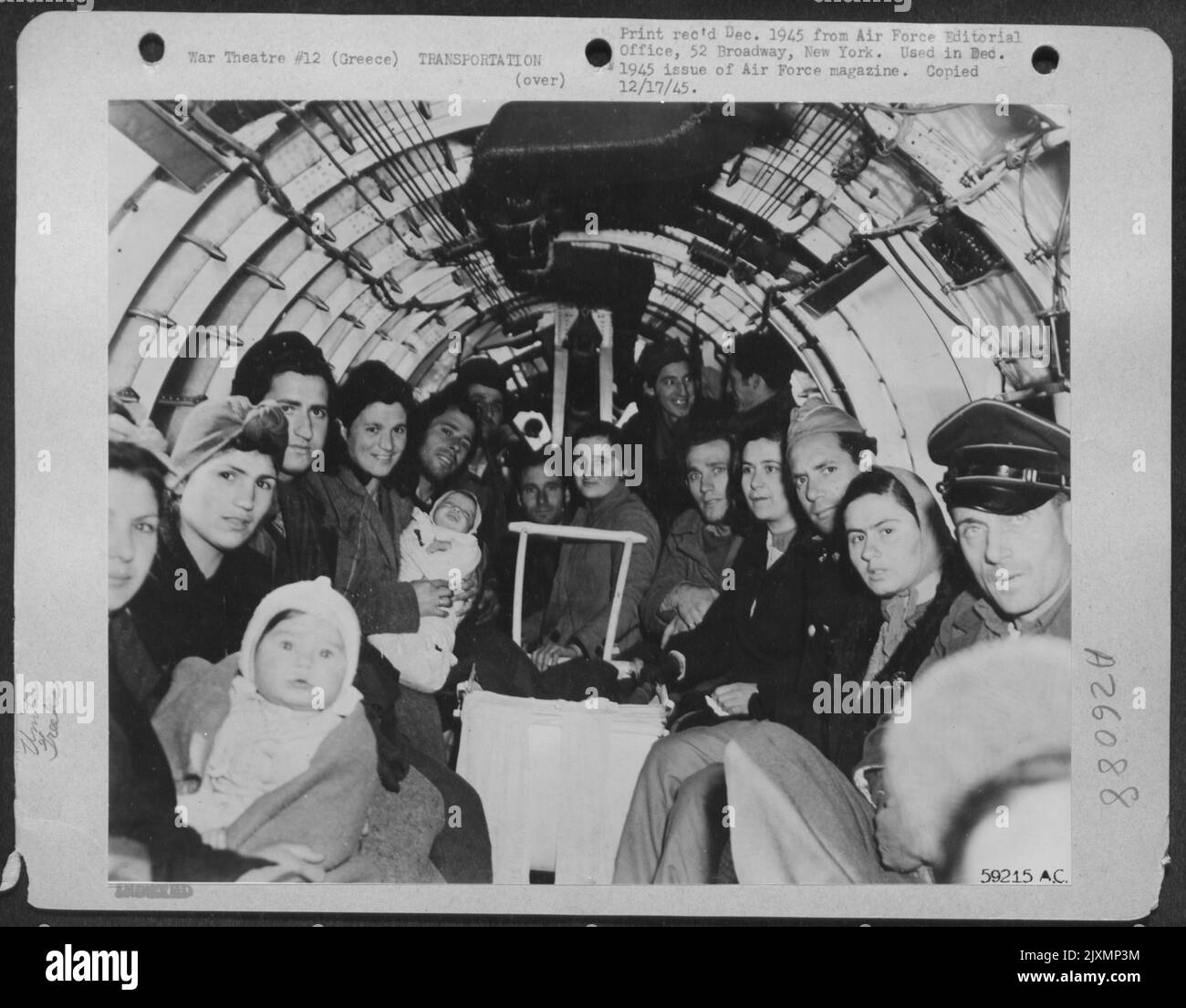 In the waist of a 40th Bomb Wing B-17 Flying Fortress, young and old of ...