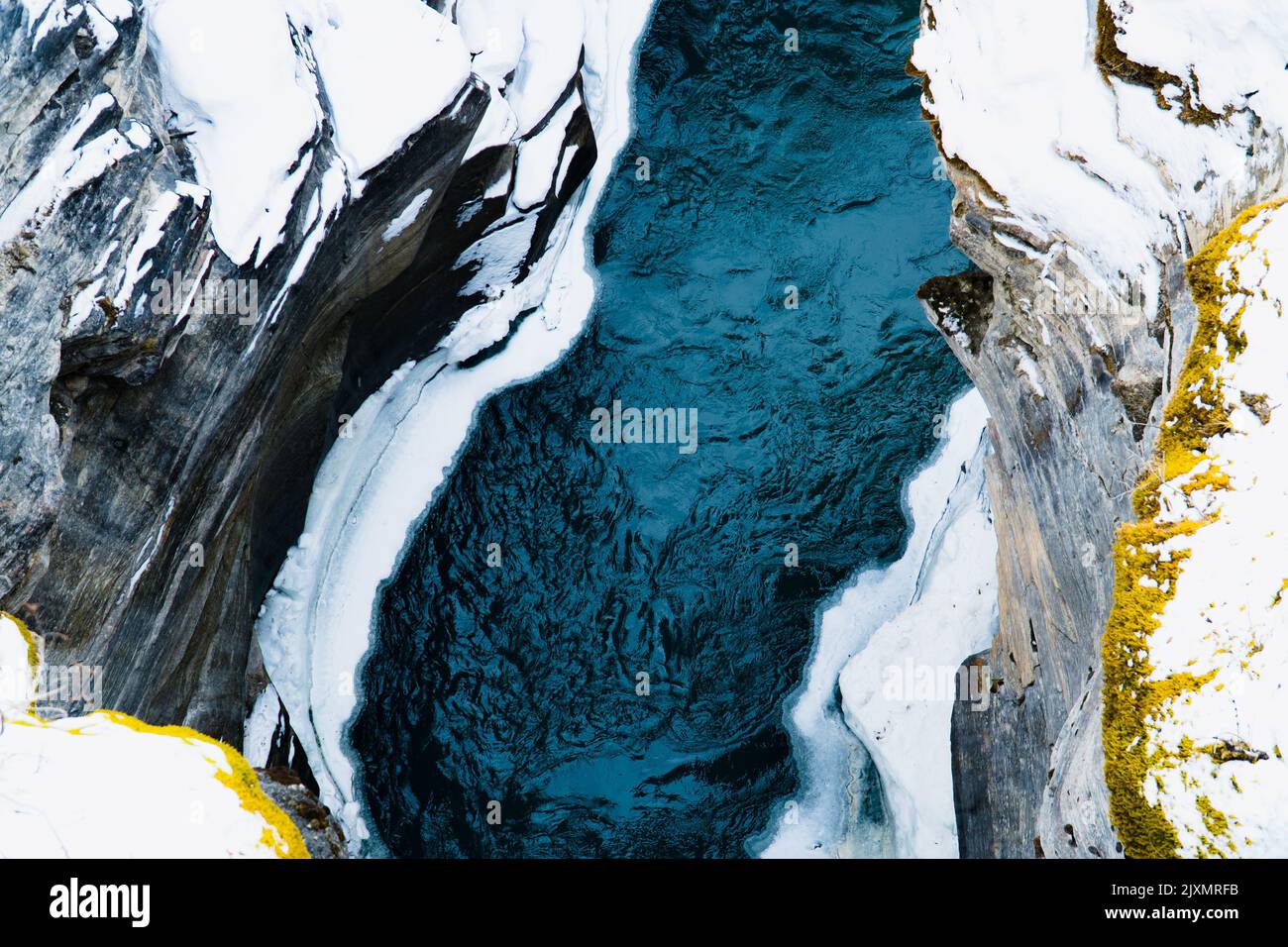 A top view of a beautiful clear blue river in the rocky canyon covered ...