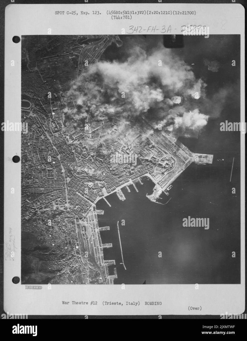 Bombs burst on the shipping yards at Trieste, Italy on 20 February 1945 ...