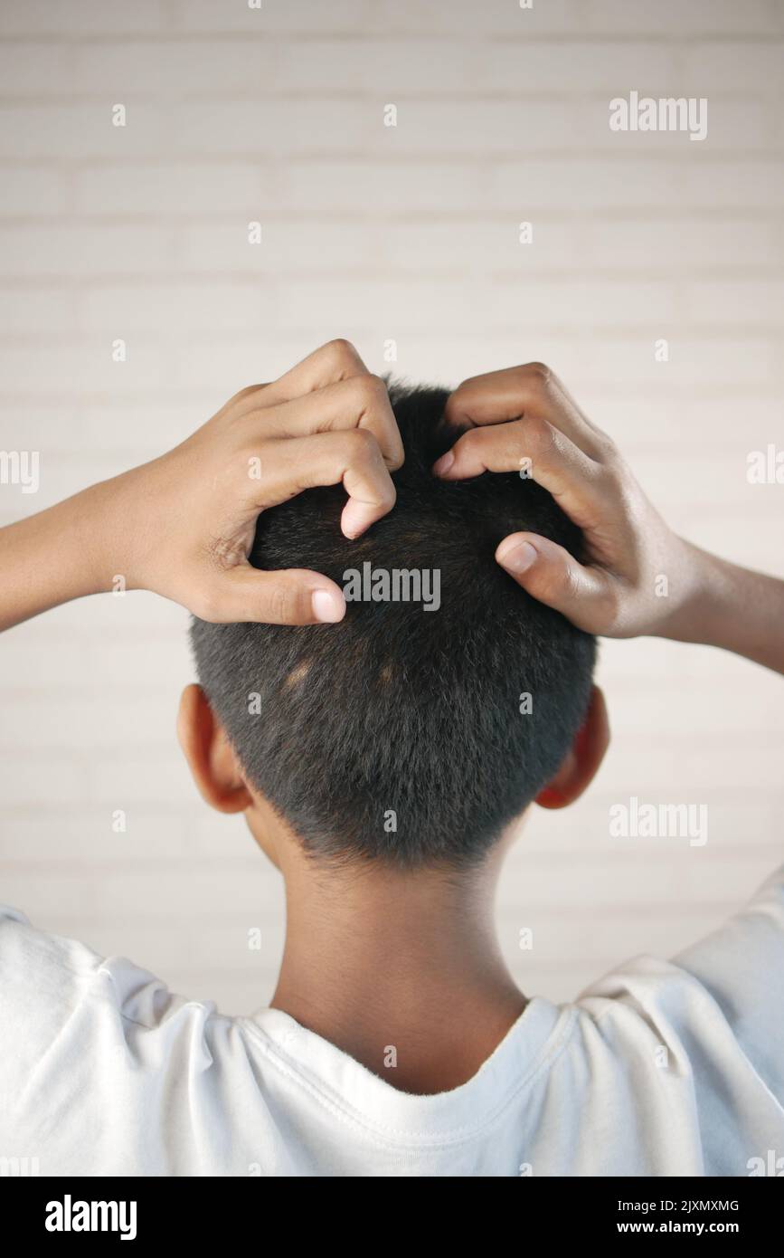 teenage boy Scratching Head Against black background Stock Photo - Alamy