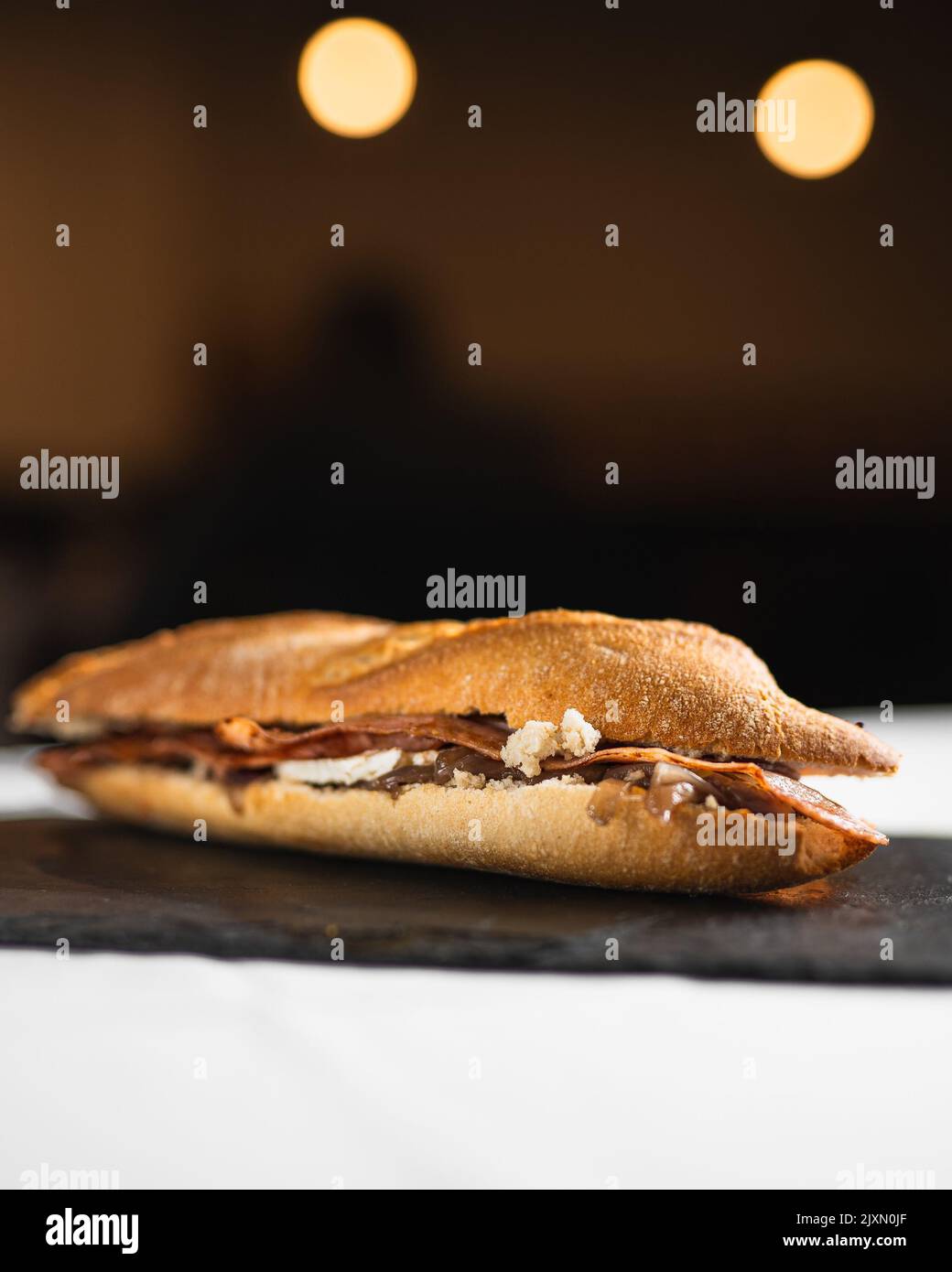 Bacon goat cheese bocadillo on a rustic bread Stock Photo - Alamy