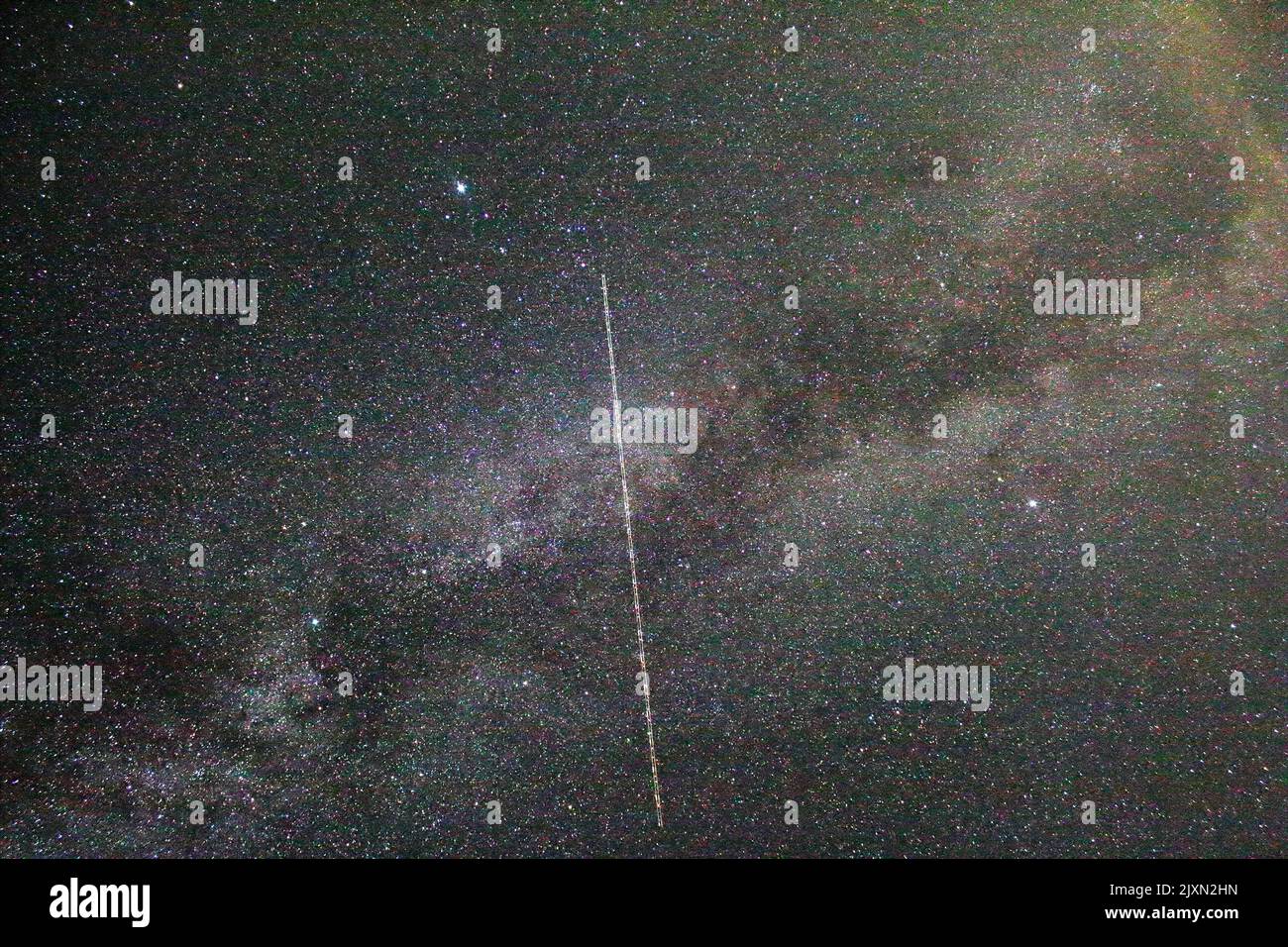 A long exposure of the Milky Way an a plane crossing the set Stock ...