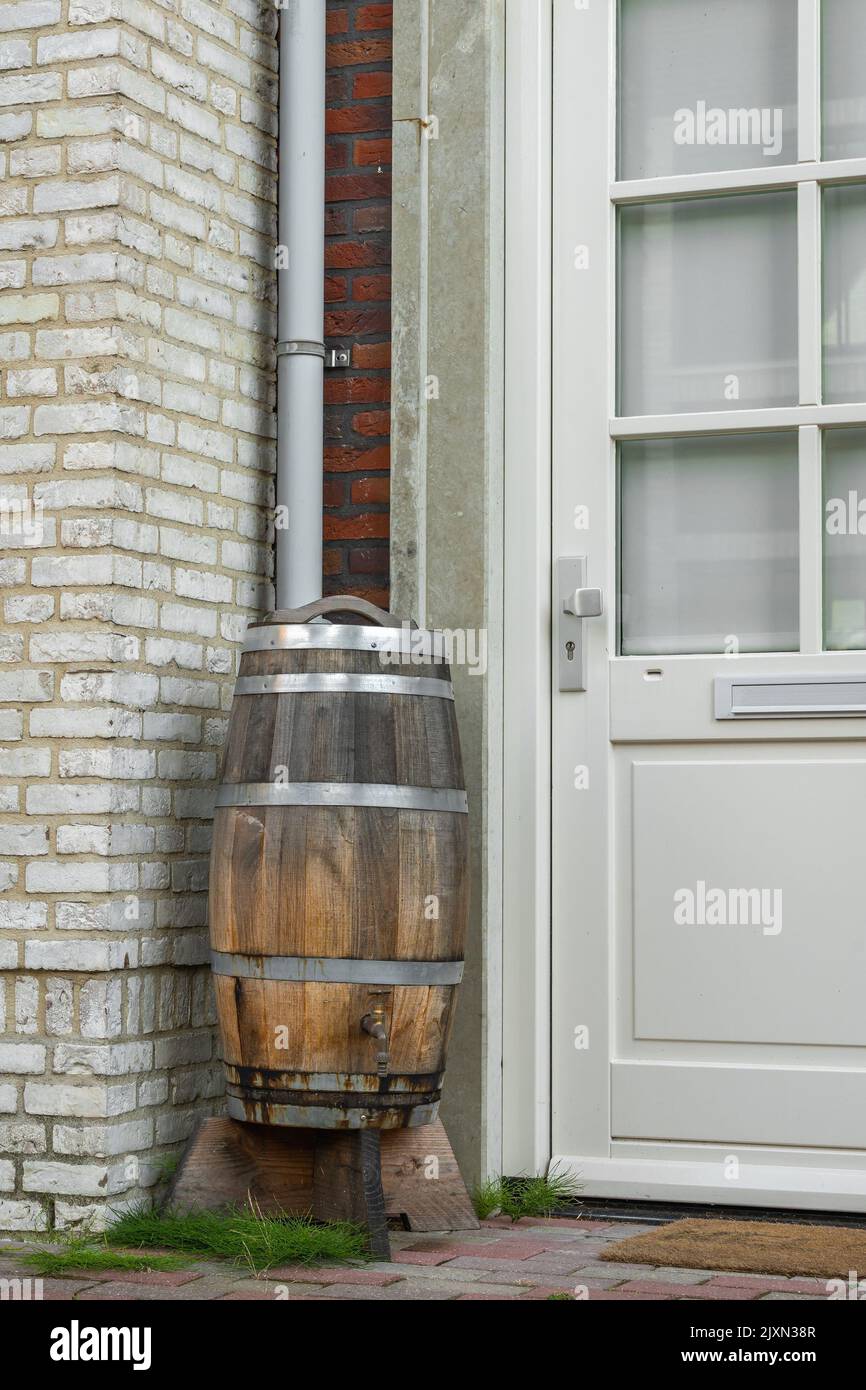 Wooden rain barrel for collection of rain water Stock Photo - Alamy