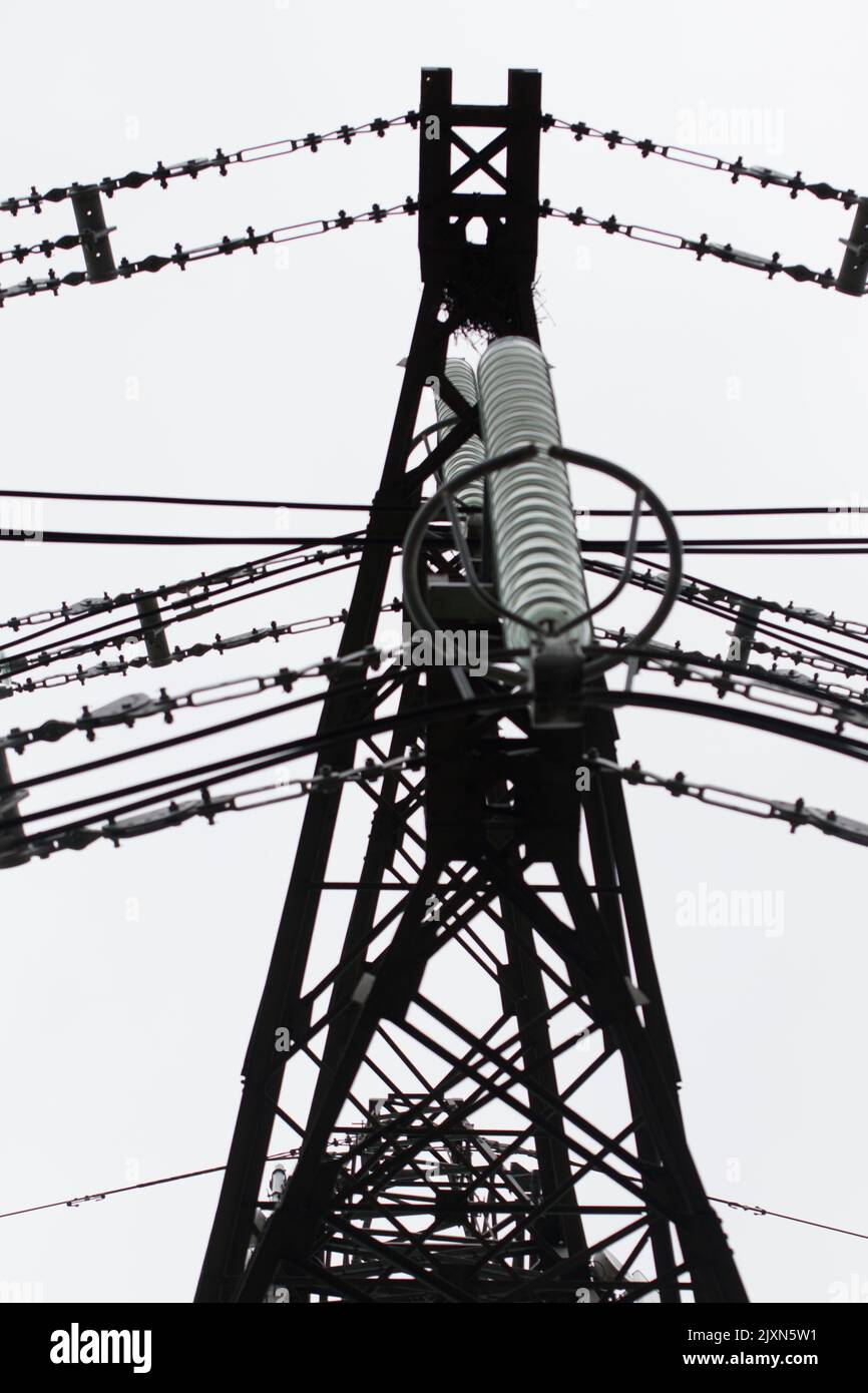 A vertical shot of a high voltage transmission electrical tower on a ...