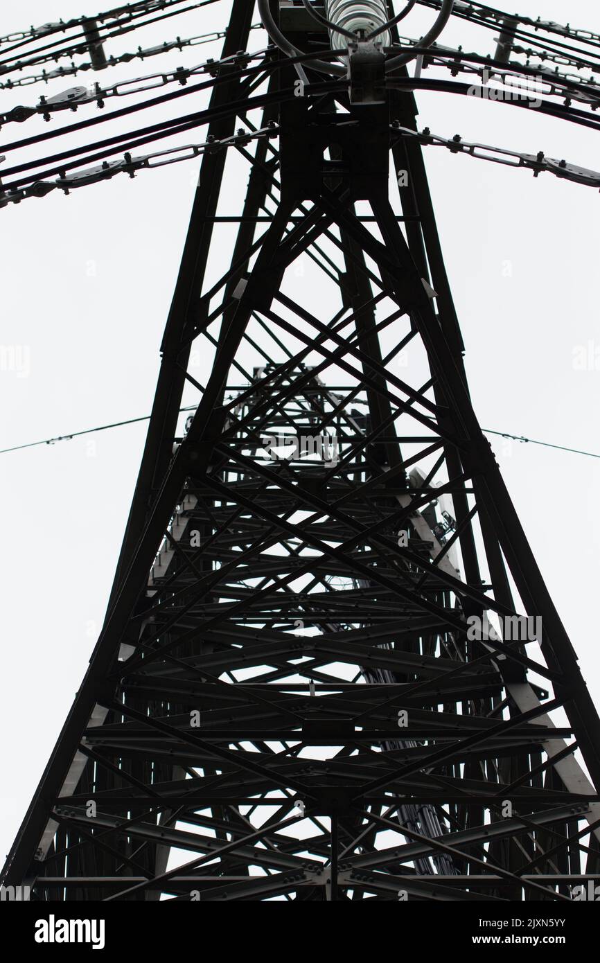 A vertical shot of a high voltage transmission electrical tower on a ...