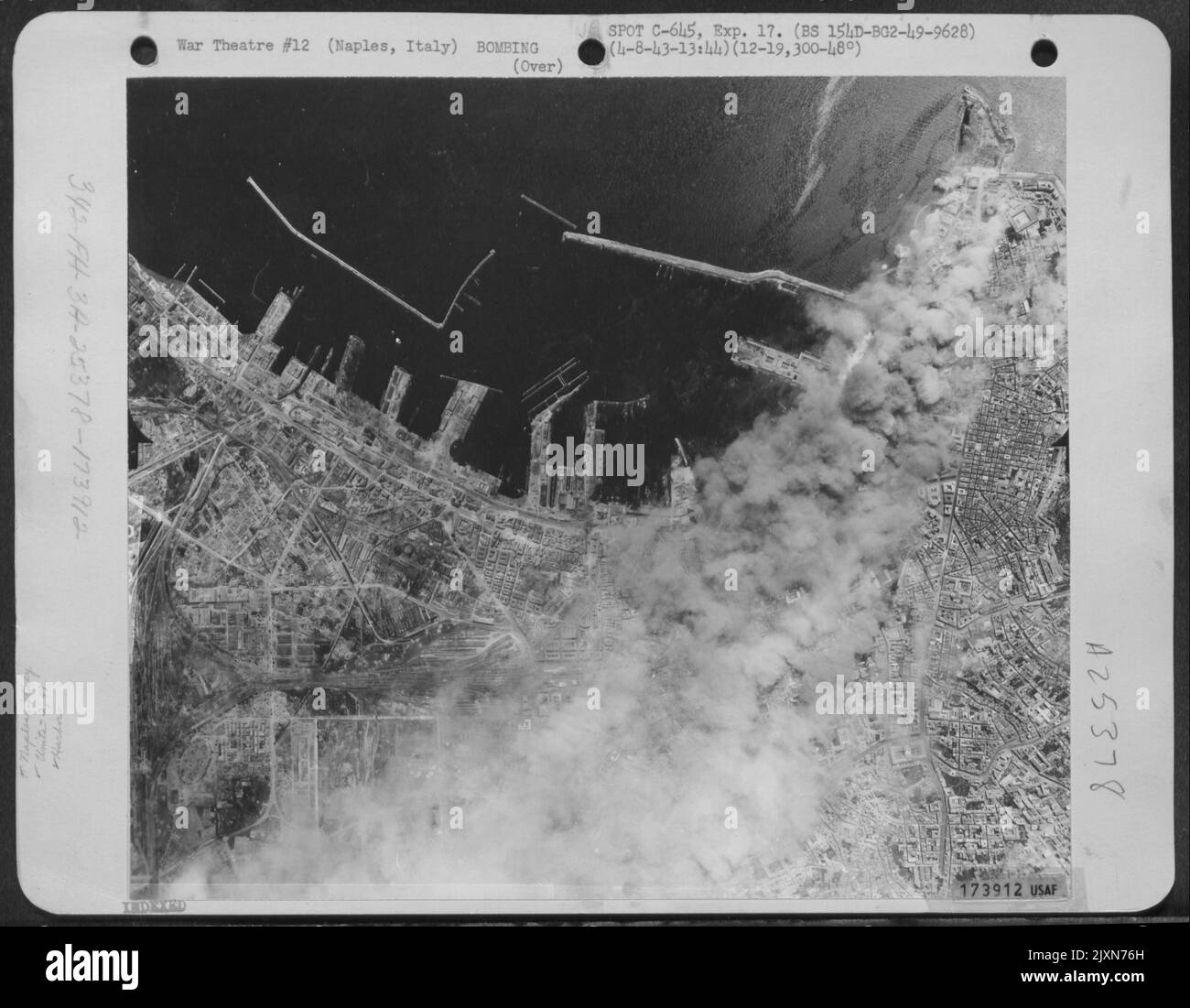 Bomb bursts cover many installations at the harbor of Naples, Italy on ...