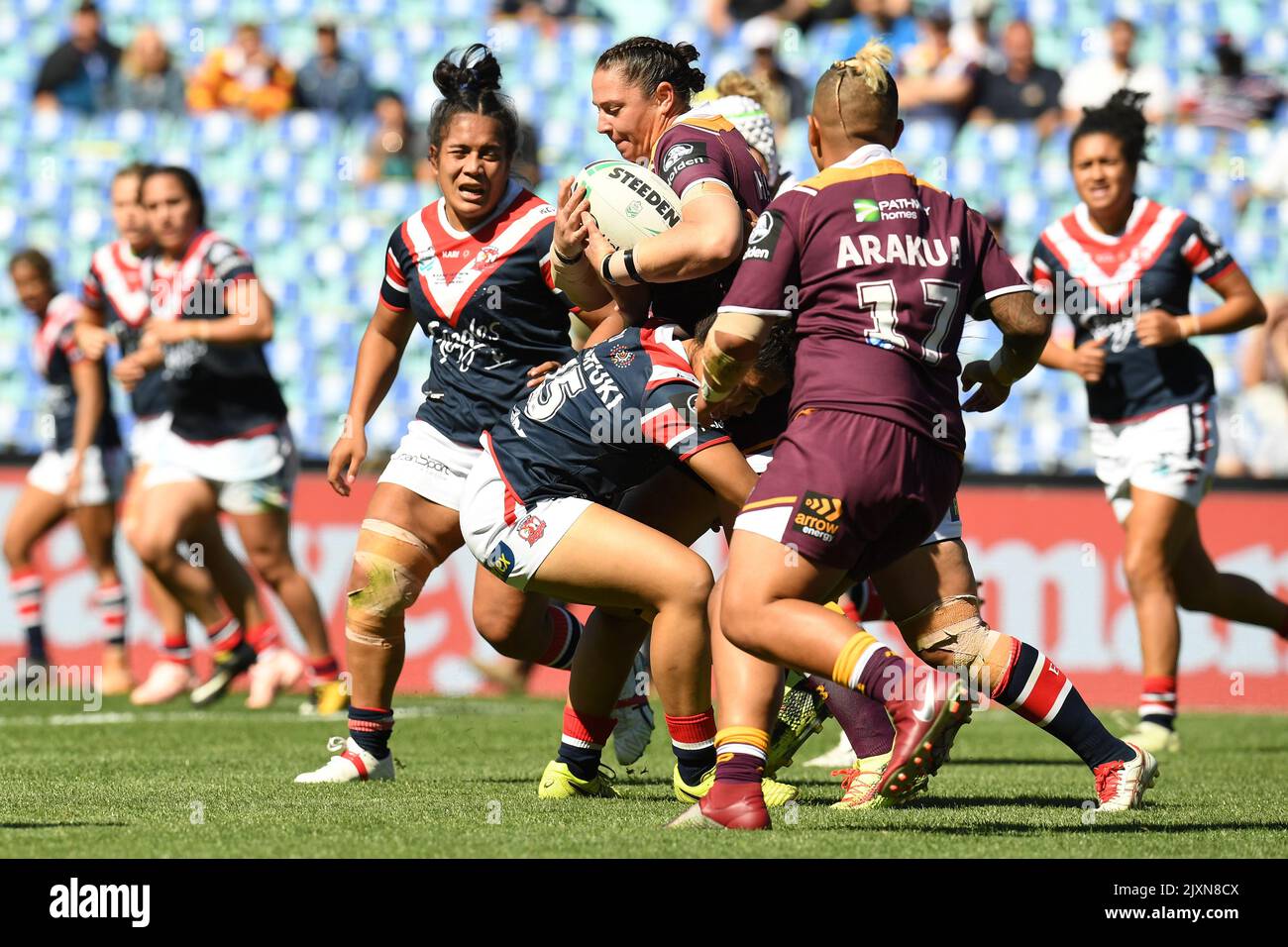 Stephanie Hancock of the Broncos is tackled by Sarah Togatuki of the ...