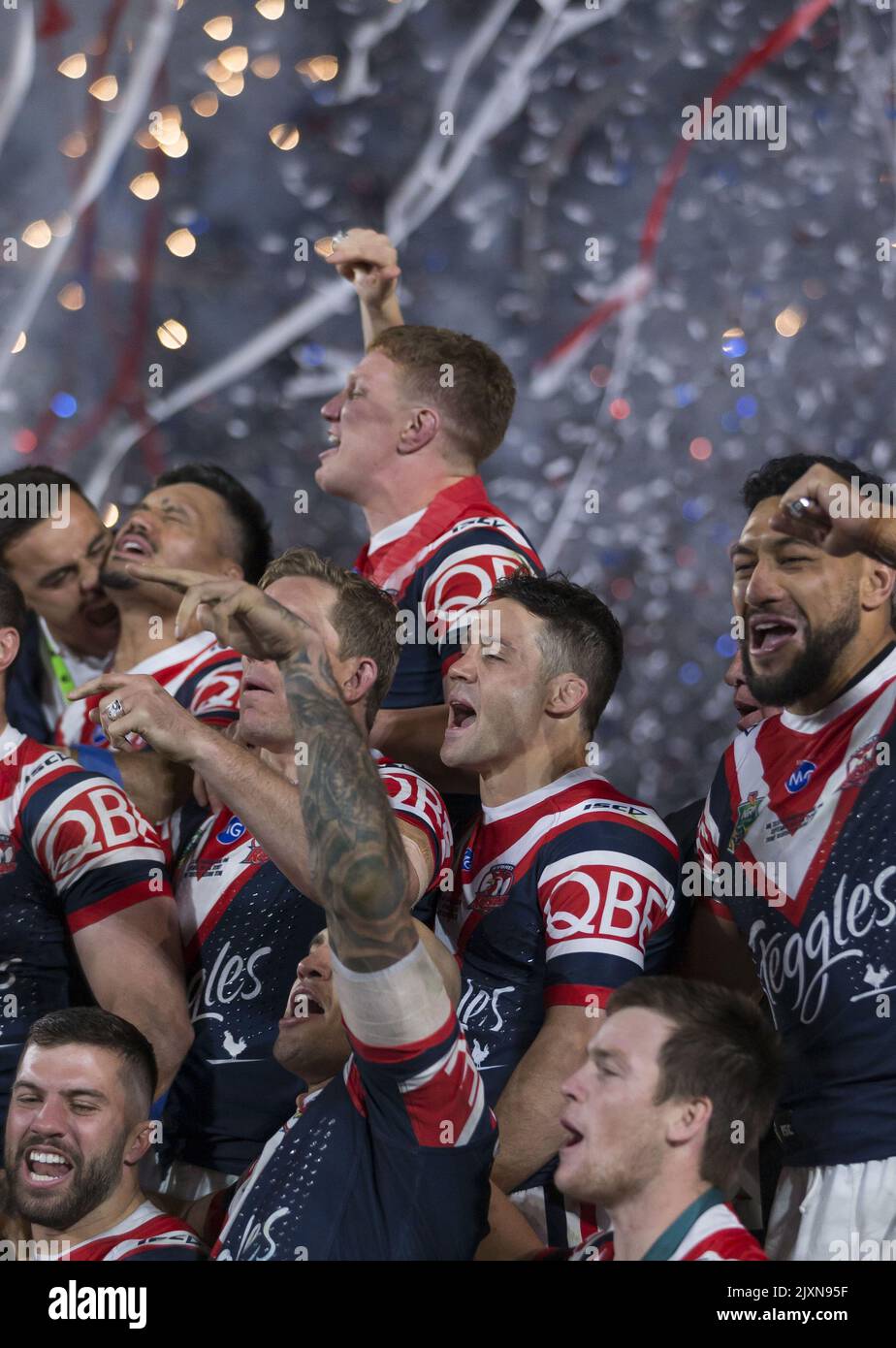 Cooper Cronk of the Roosters sings on the podium with team after the ...