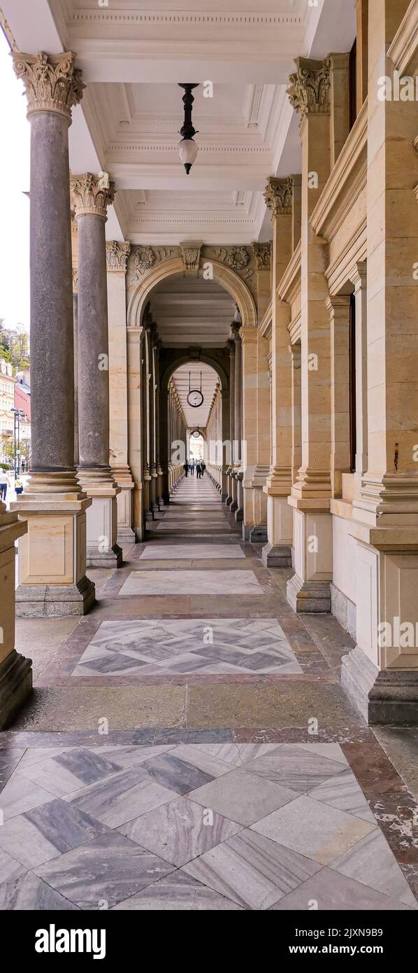 A vertical of a walkway with colonial columns Stock Photo - Alamy