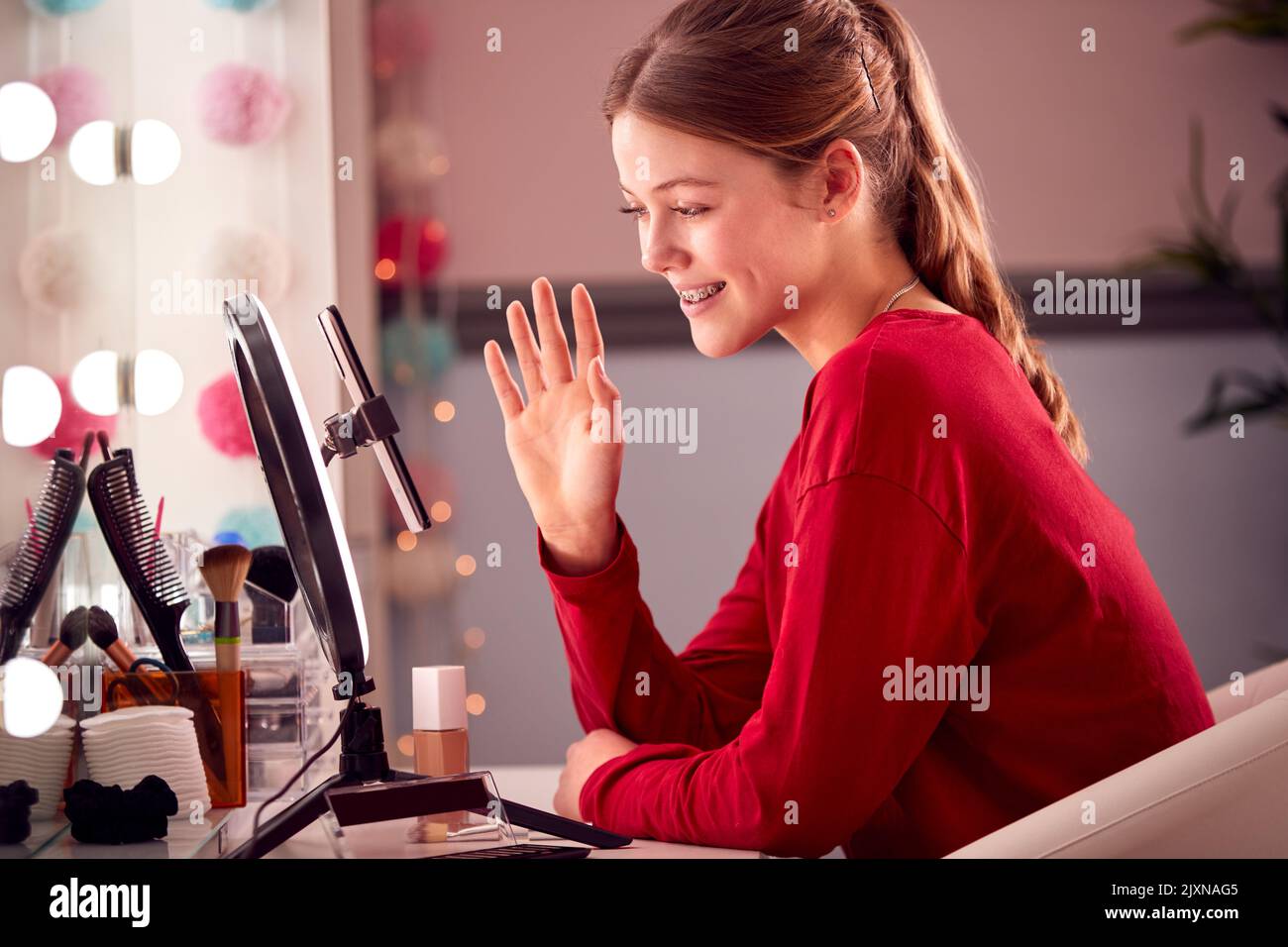 Teenage Girl In Bedroom Recording Online Make Up Tutorial On Mobile ...