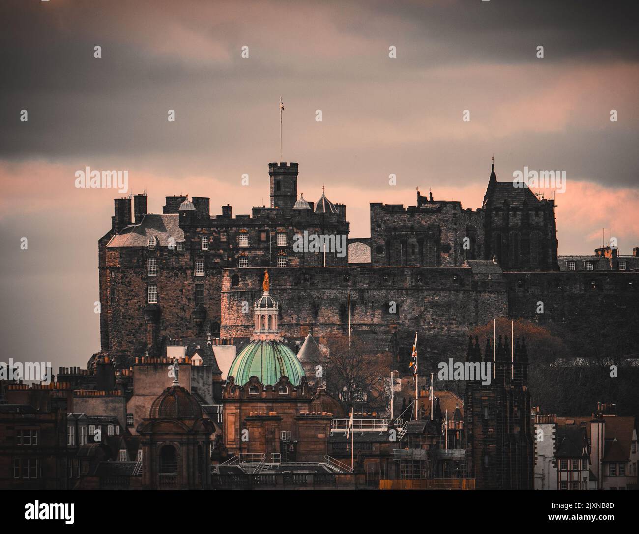 A beautiful view of Edinburgh Castle at soft pink sunset Stock Photo ...