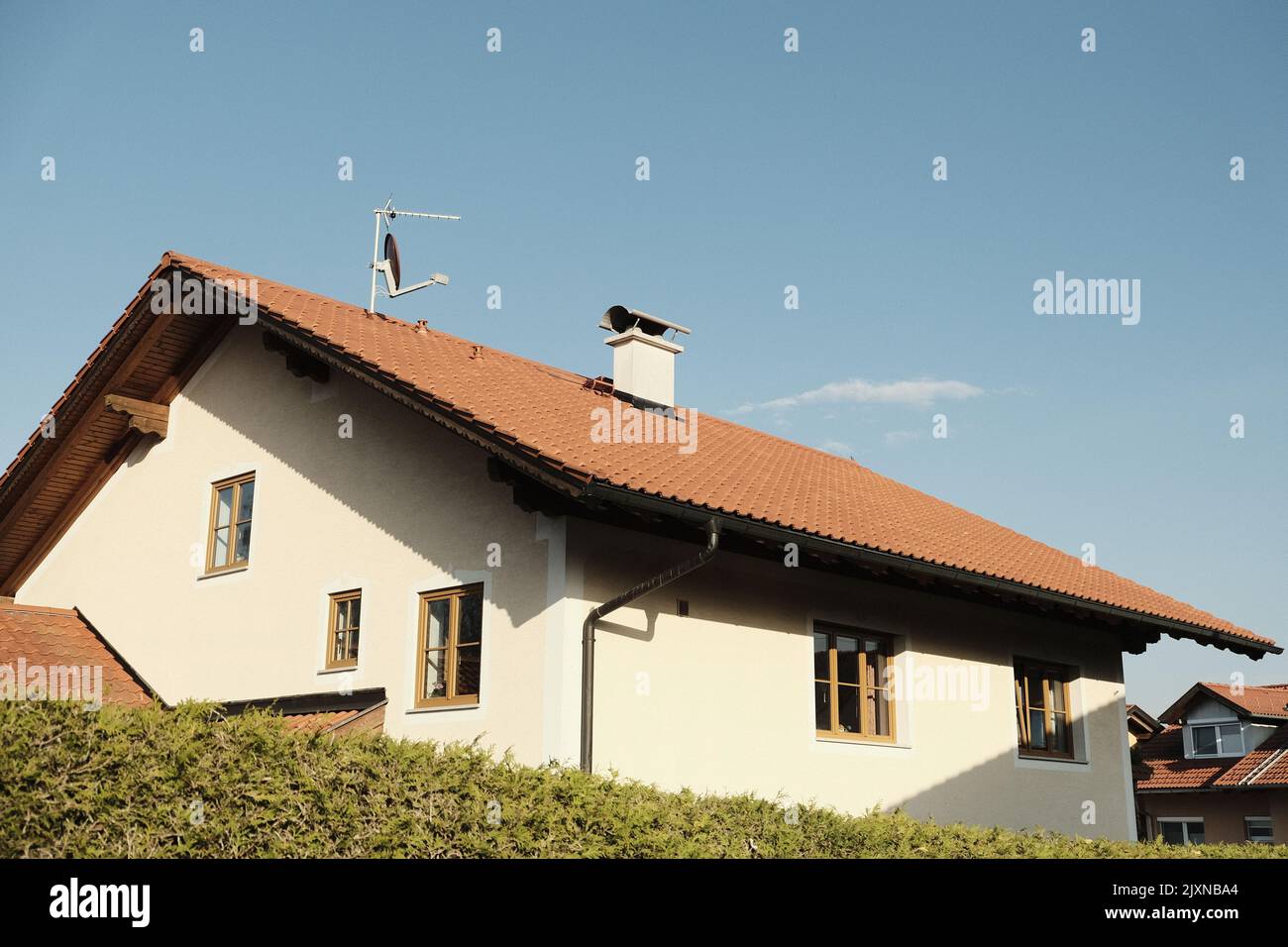 A modern house with a chimney on its roof Stock Photo - Alamy