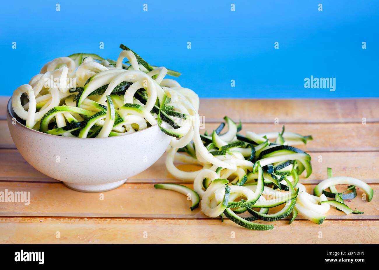 A bowl filled with spiralized courgette or zucchini. Used as a Keto ...