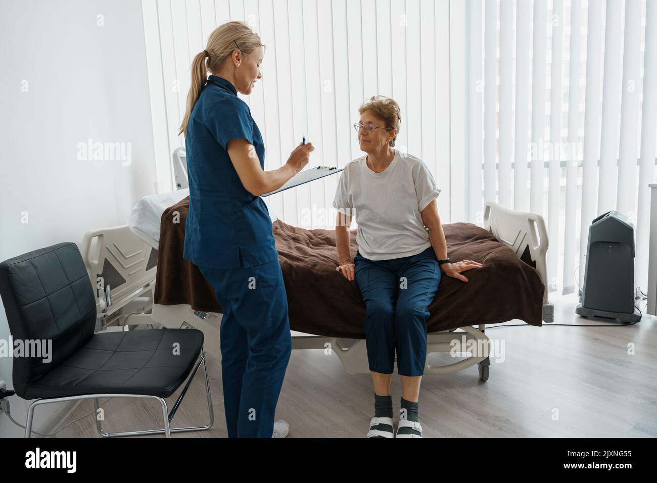 Professional doctor in uniform examines the patient during a visit to ...