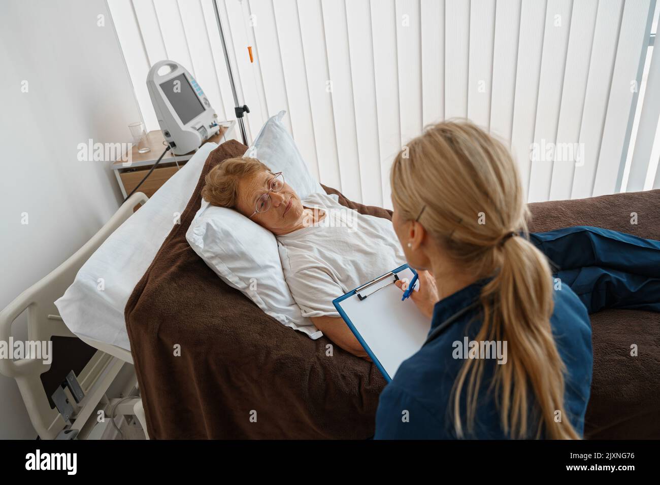 Professional doctor in uniform examines the patient during a visit to ...