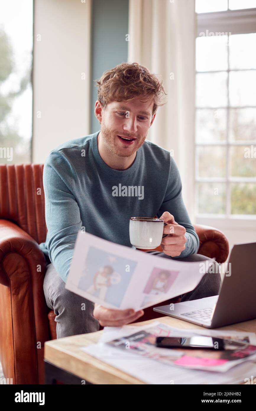 Man Working From Home In Creative Design Or Marketing Industry Checking ...