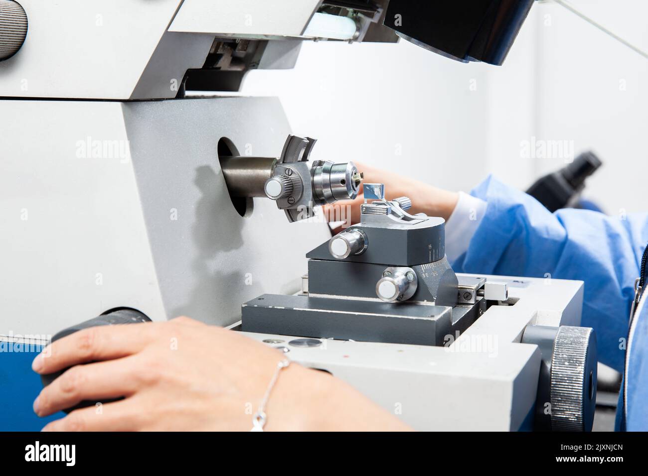 Closeup of a female scientist using an ultramicrotome to make sections ...