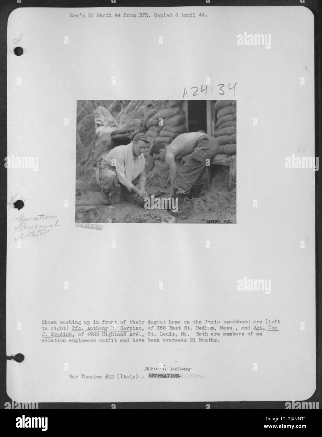 Shown washing up in front of their dugout home on the Anzio beachhead ...