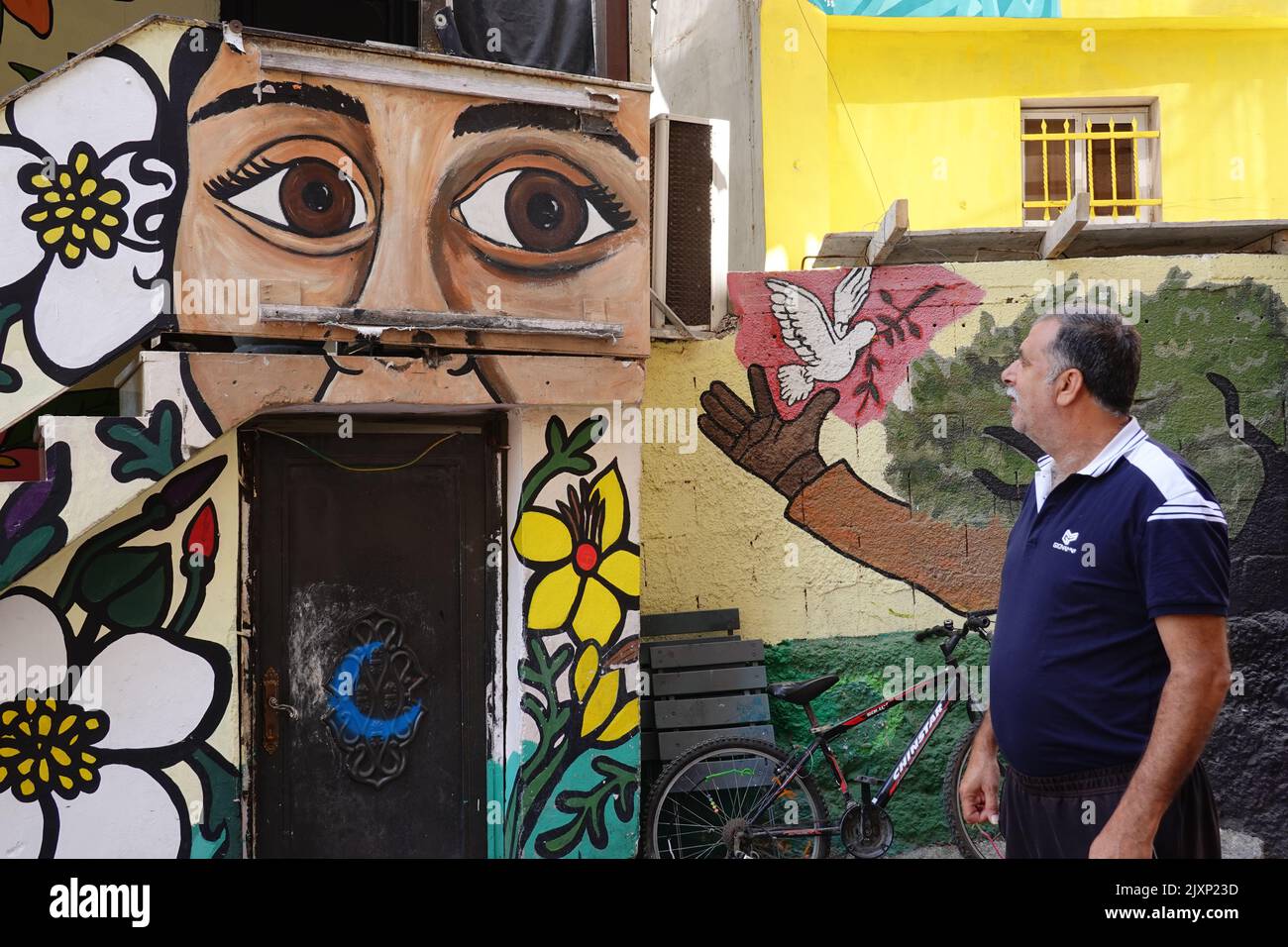 Jerusalem. 6th Sep, 2022. A man views a wall with murals in the Arab ...