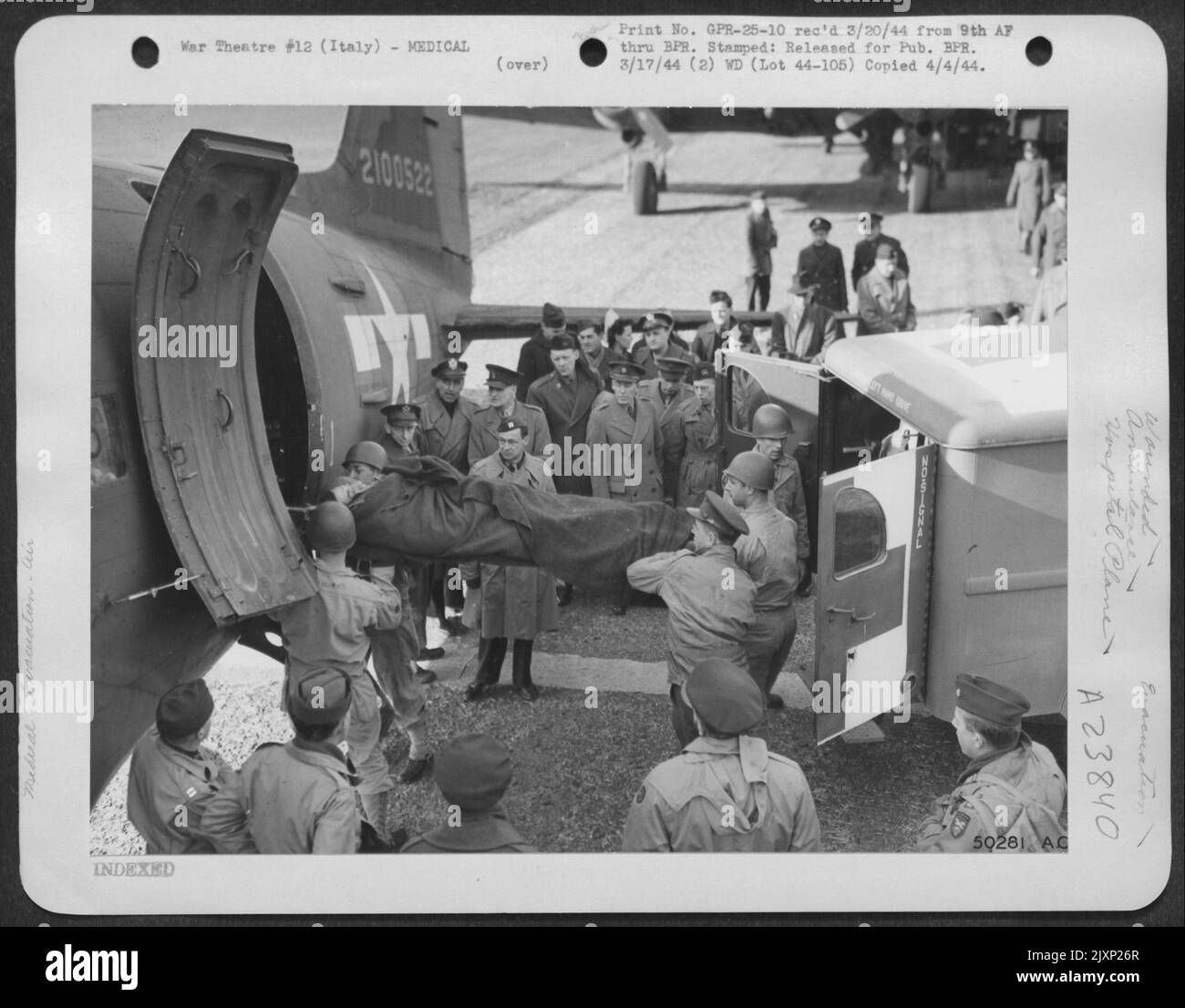 An air evacuation unit of the 9th USAF is shown loading a soldier ...