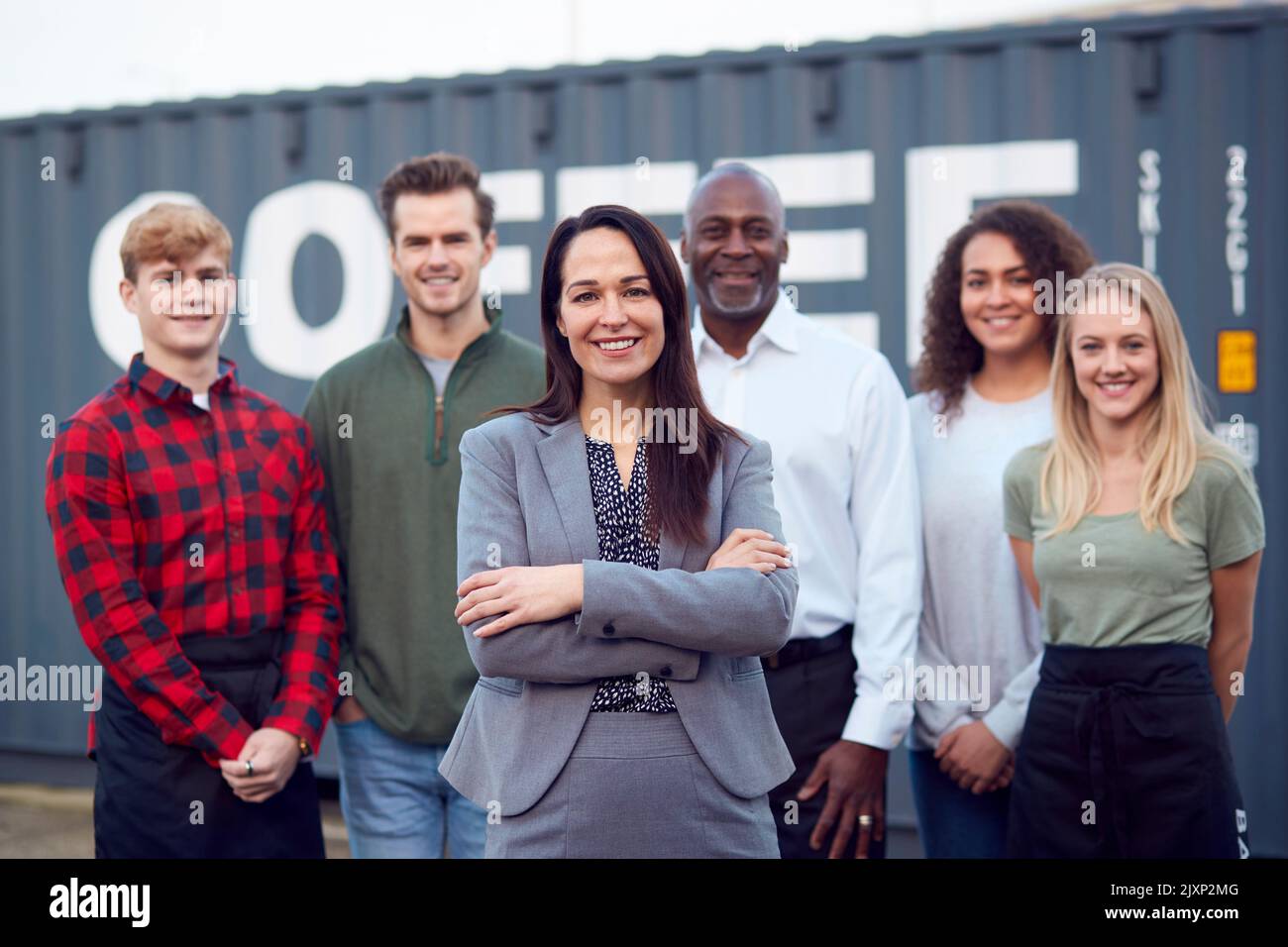 Portrait Of Multi-Cultural Freight Haulage Team Standing By Shipping ...