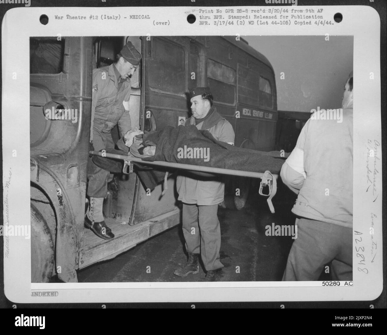 Receiving crew members of a 9th USAF Evacuation unit are shown loading ...
