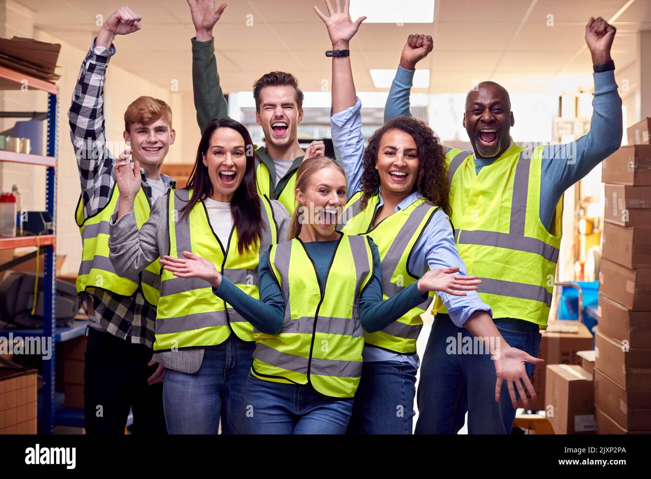 Portrait Of Cheering Multi-Cultural Team Wearing Hi-Vis Safety Clothing ...