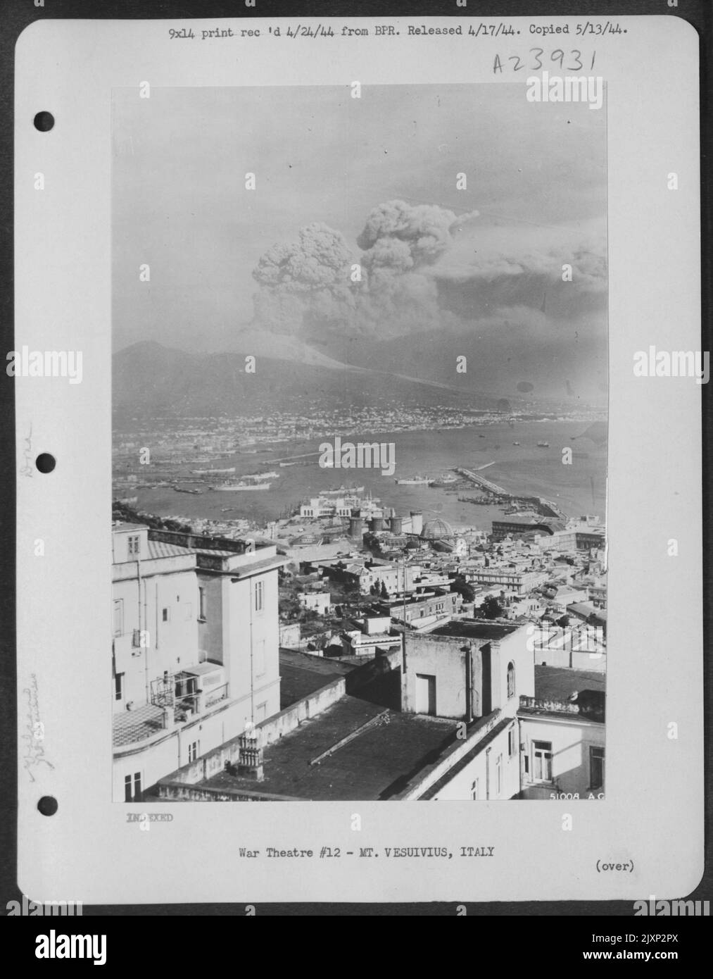 Scene from a hill high above Naples, Italy. Mt. Vesuvius spouts lava ...