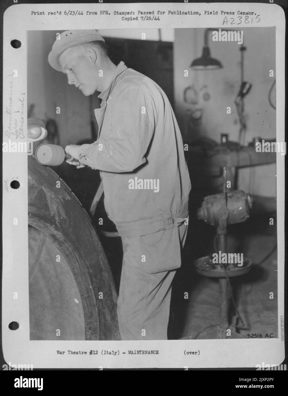 Pfc. Robert Frick puts the finishing touches on the tire, smoothing the ...