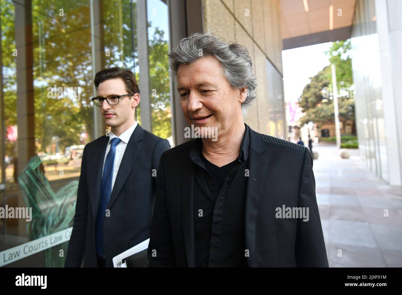 Theatre director Simon Phillips (right) leaves the Federal Court in ...