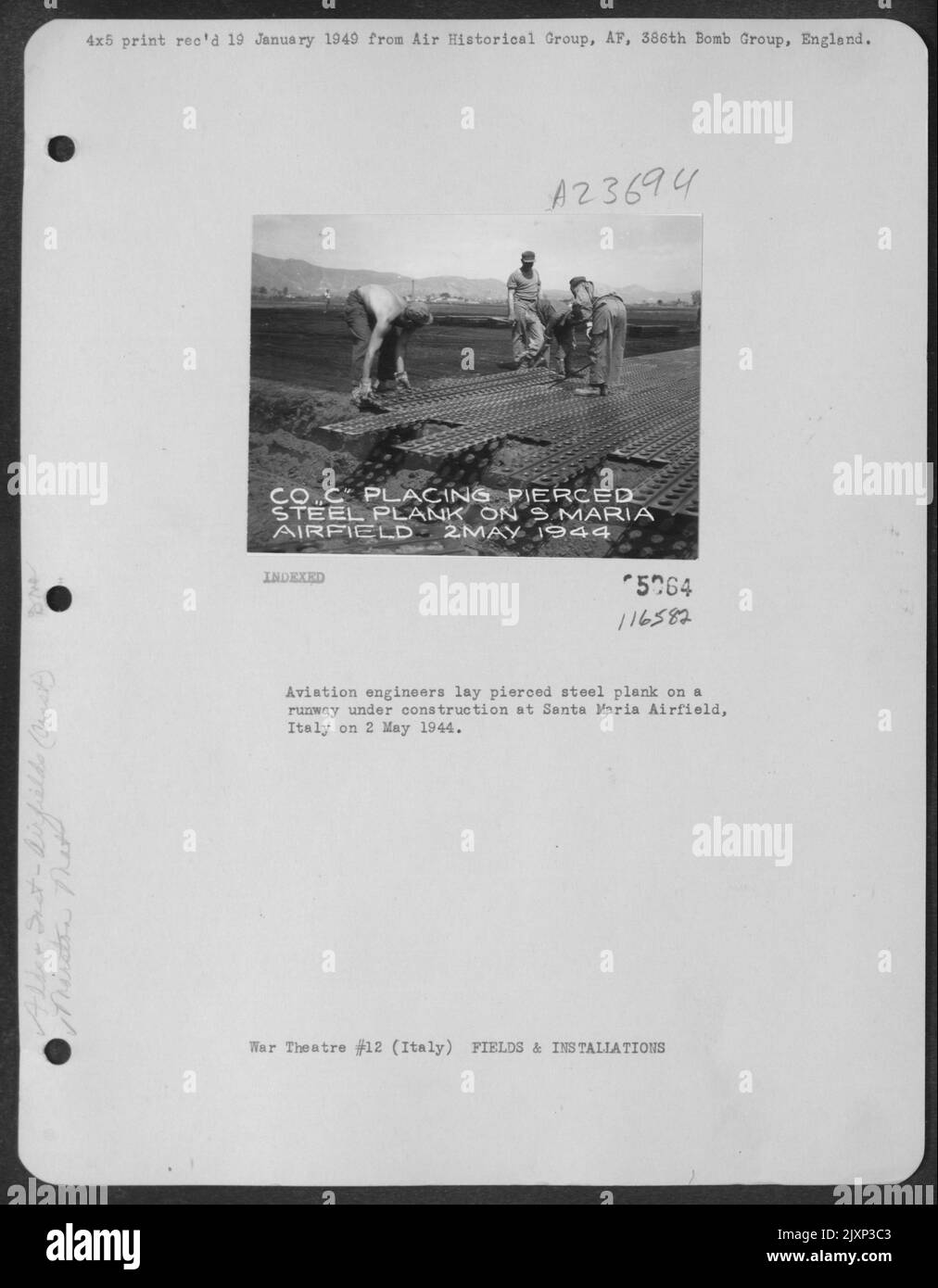 Aviation engineers lay pierced steel plank on a runway under ...