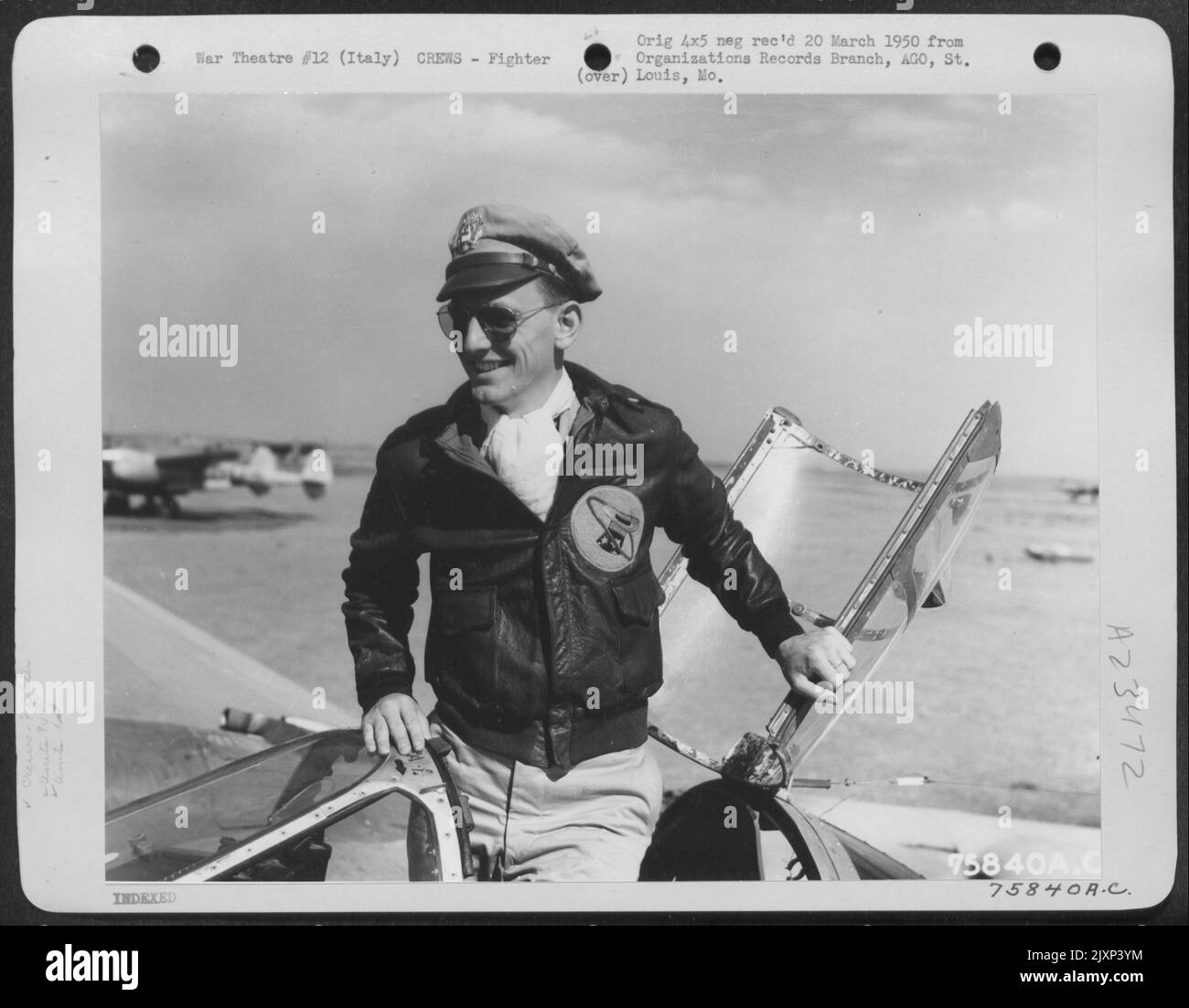 A pilot of the 94th Fighter Squadron, 1st Fighter Group, poses in the ...