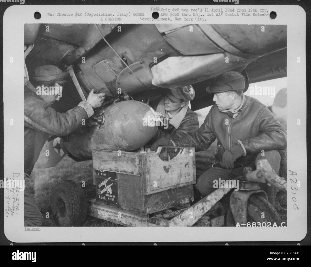 Ground Crew Men Loading A 500-Lb Bomb On A Curtiss P-40 Warhawk, Of The ...