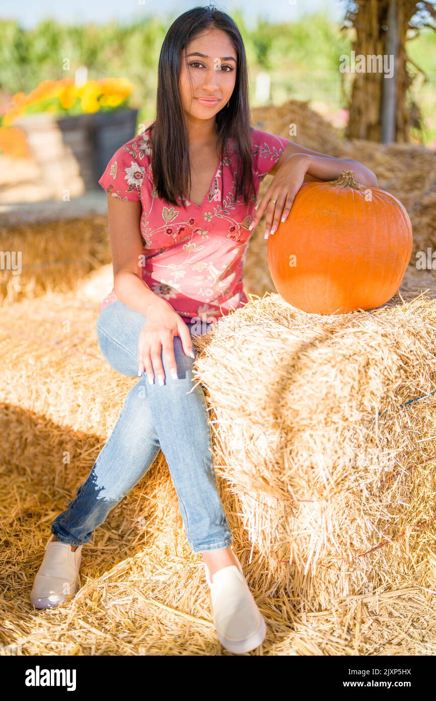Fall Celebration Portrait of Young Asian Woman Seated on a Straw Chair ...