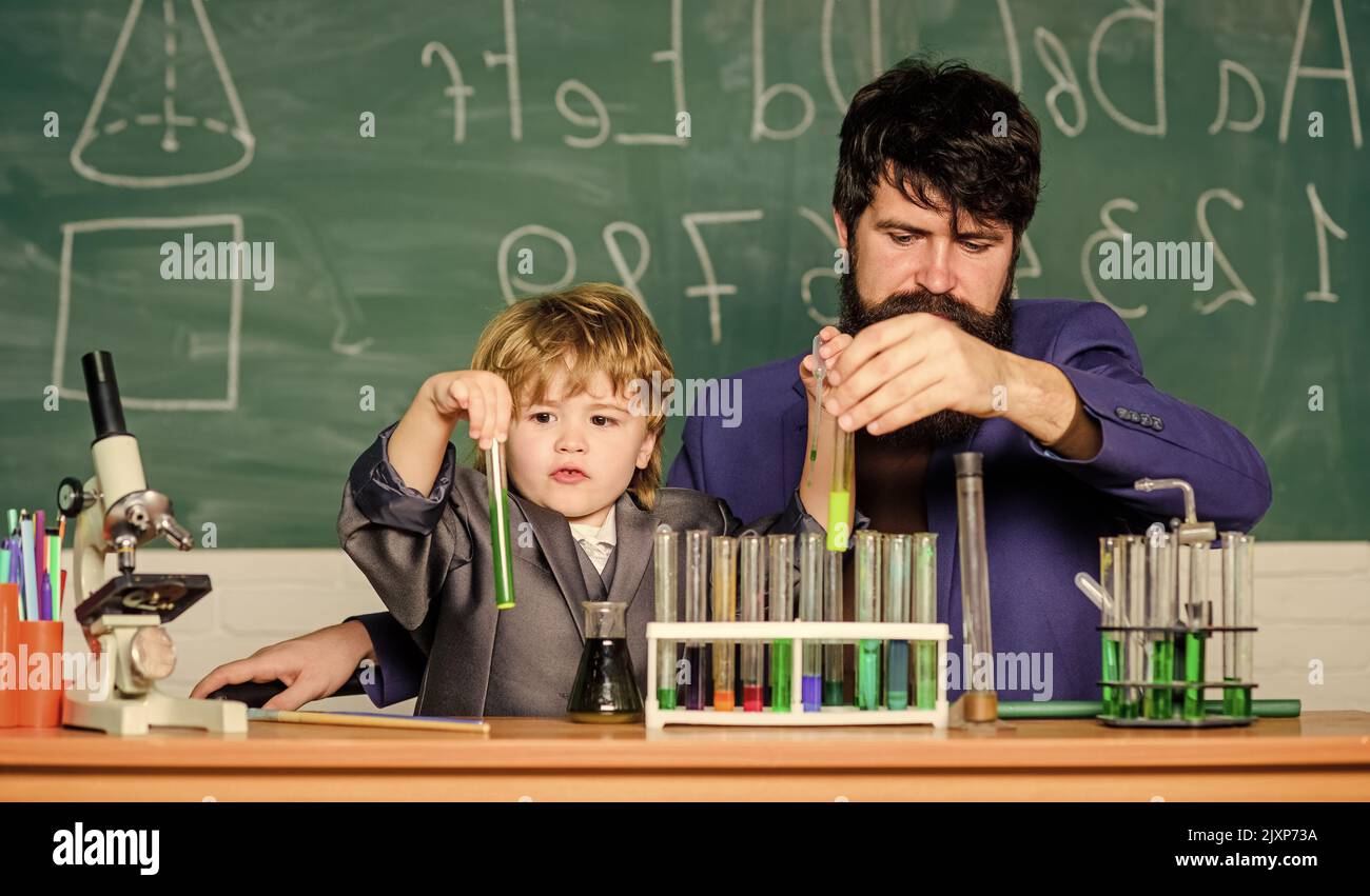 More Intelligence Solutions. man with little boy. Chemistry beaker ...