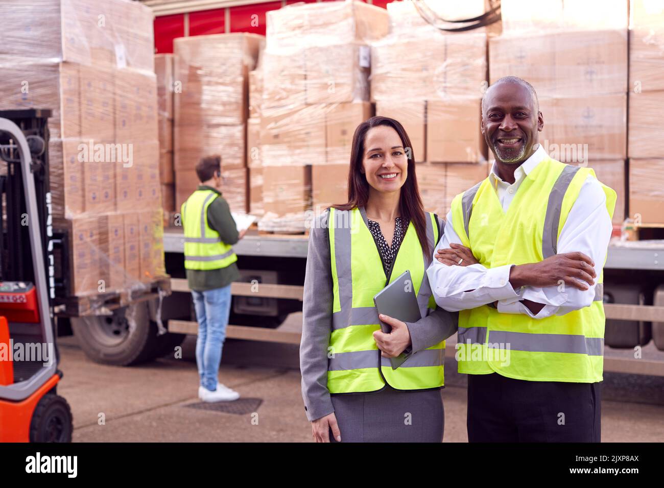 Portrait Of Multi-Cultural Freight Haulage Team Standing By Truck Being ...