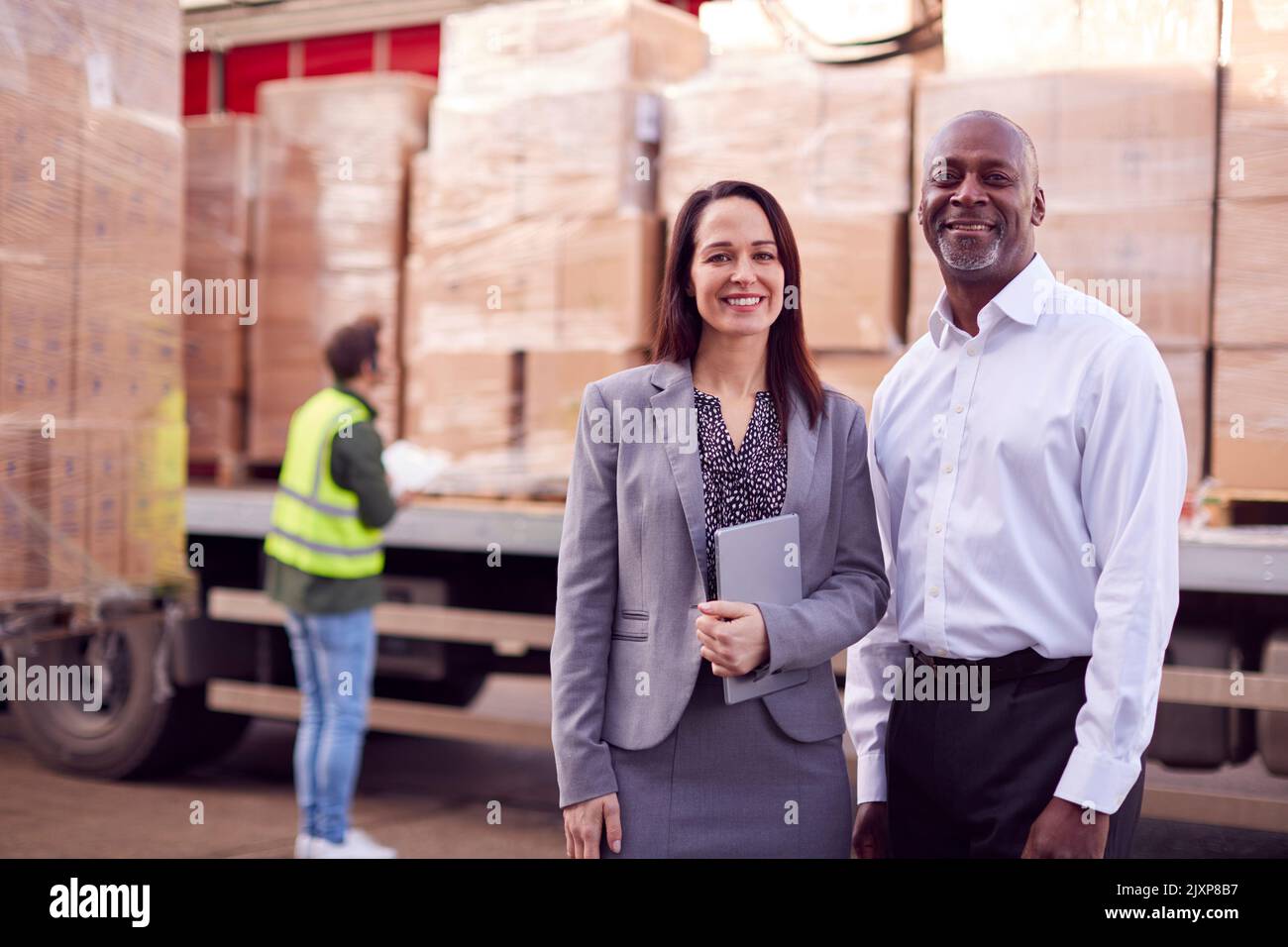 Portrait Of Multi-Cultural Freight Haulage Team Standing By Truck Being ...