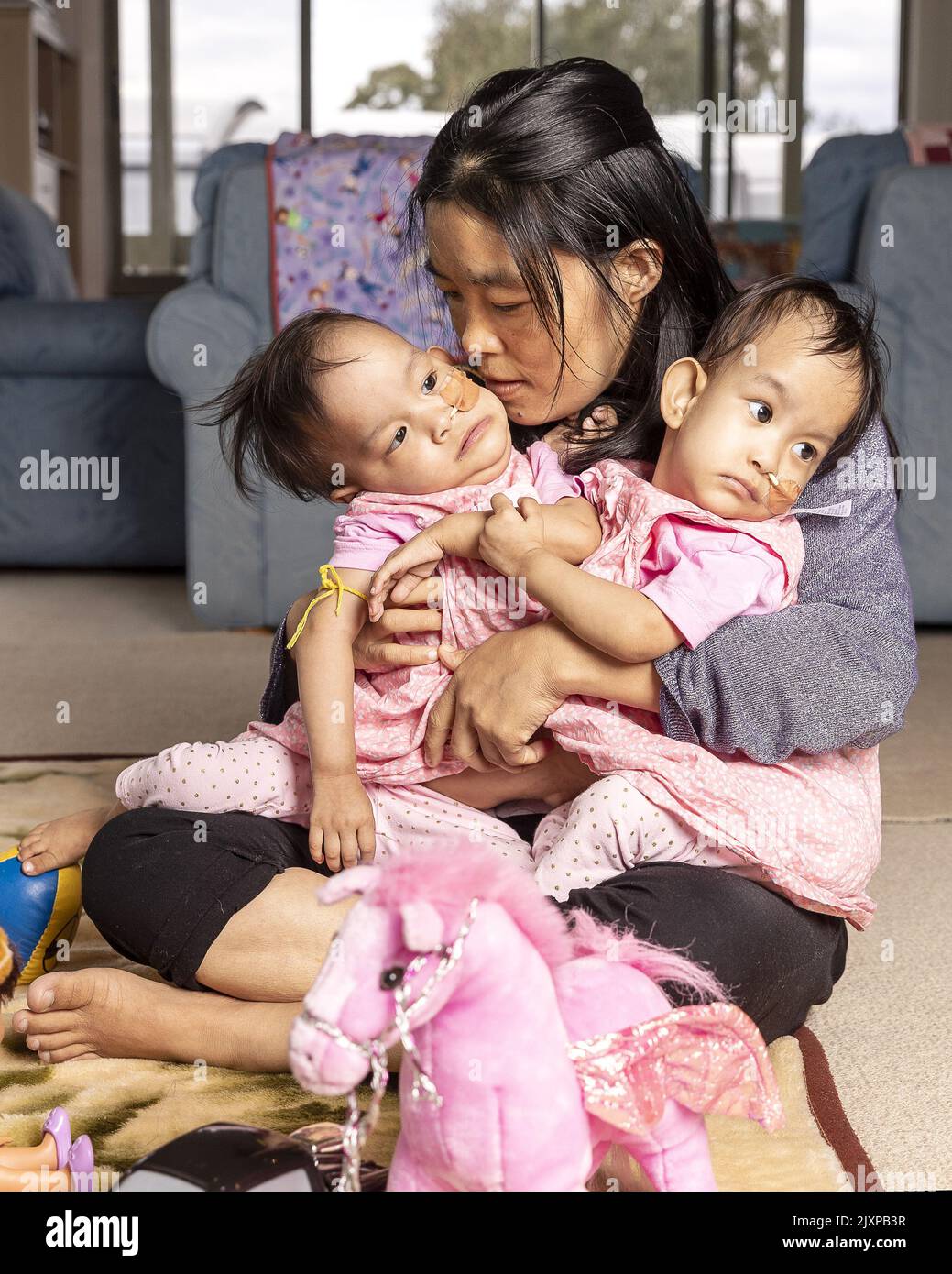 Bhumchu Zangmo is seen holding her conjoined twins Nima and Dawa at ...