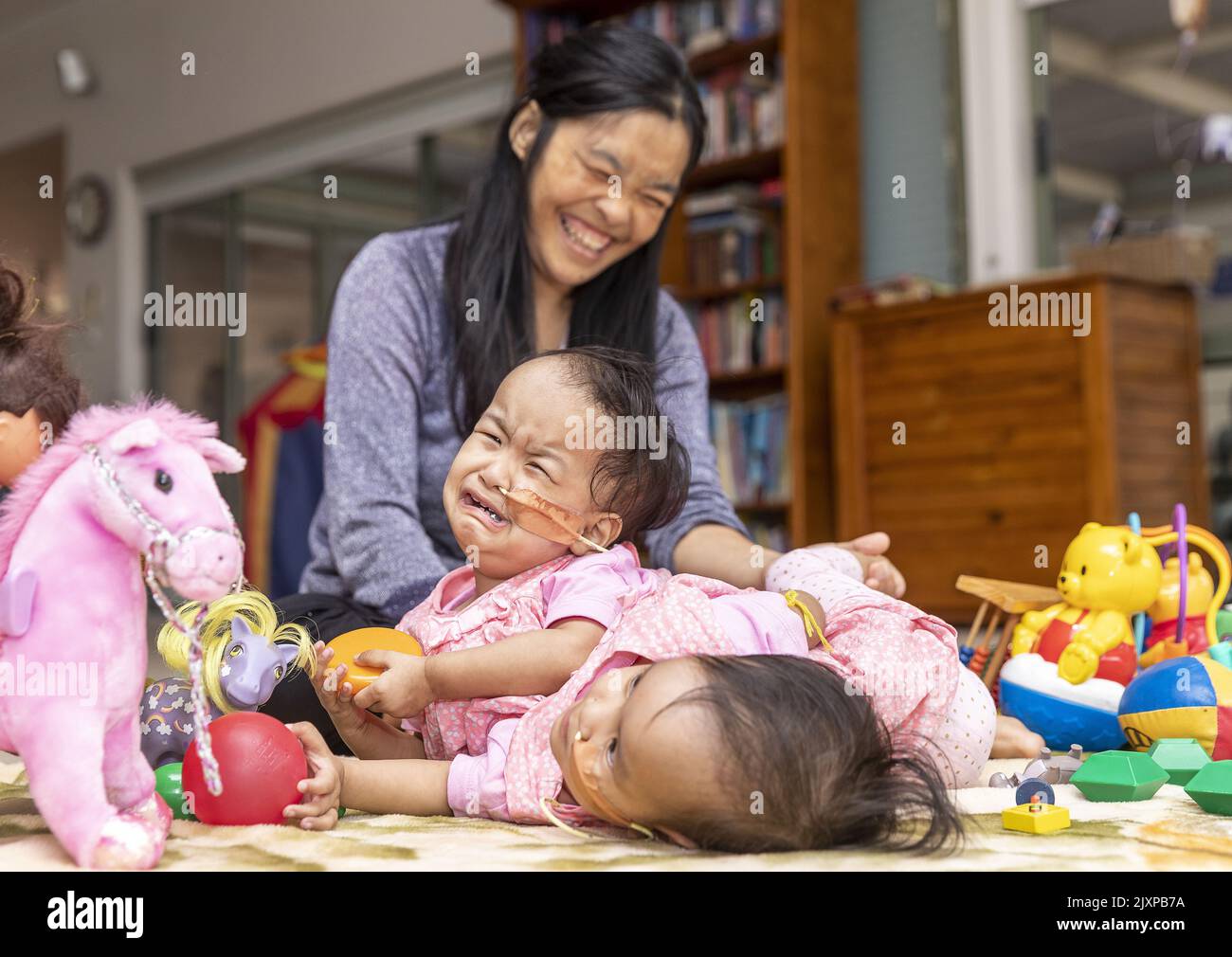 Bhumchu Zangmo is seen holding her daughters, conjoined twins Nima and ...