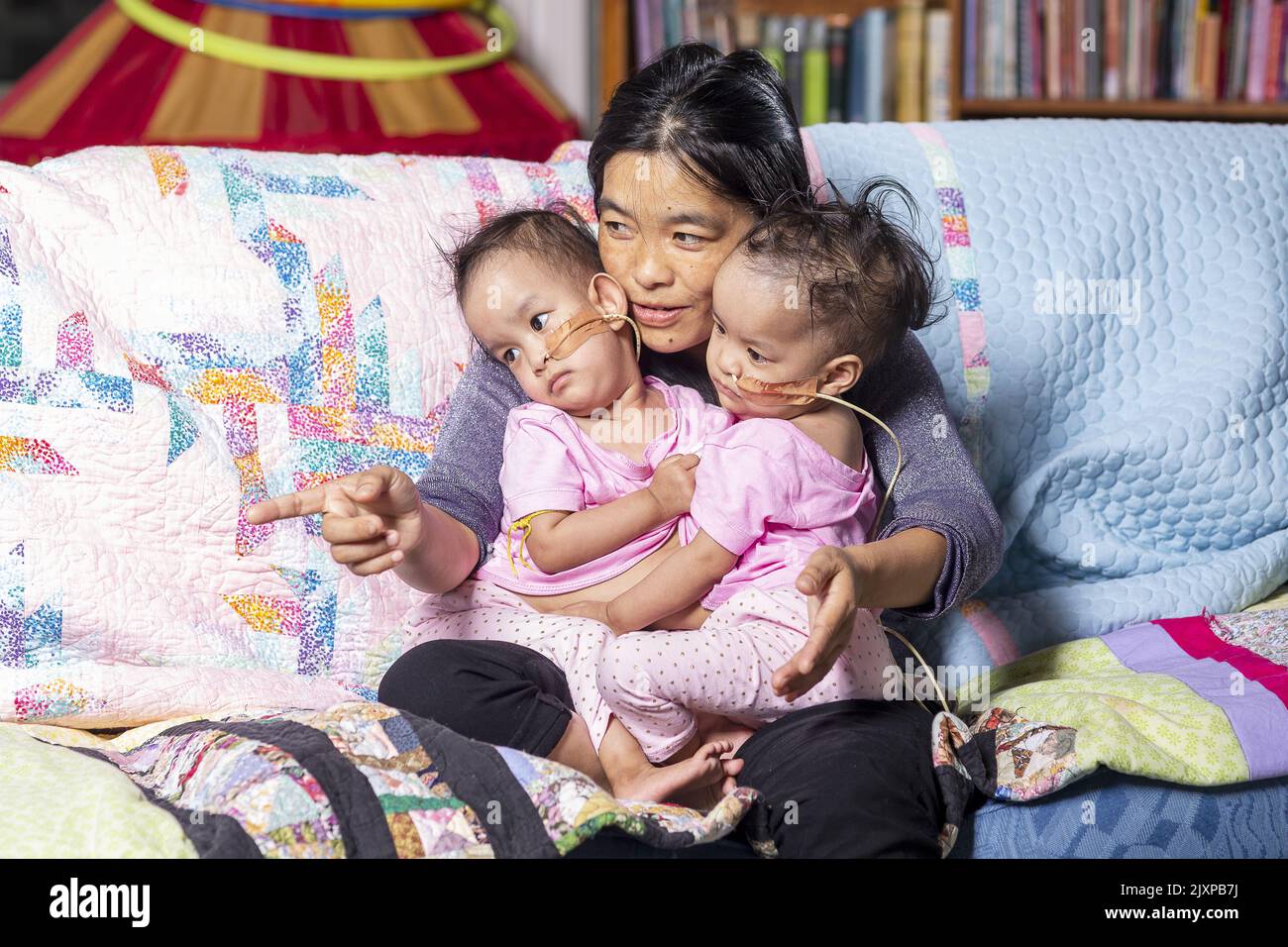 Bhumchu Zangmo is seen holding her conjoined twins Nima and Dawa at ...
