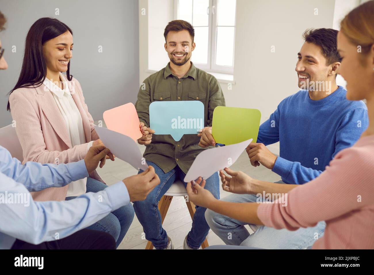 Group of happy people with speech bubbles talking during a group ...