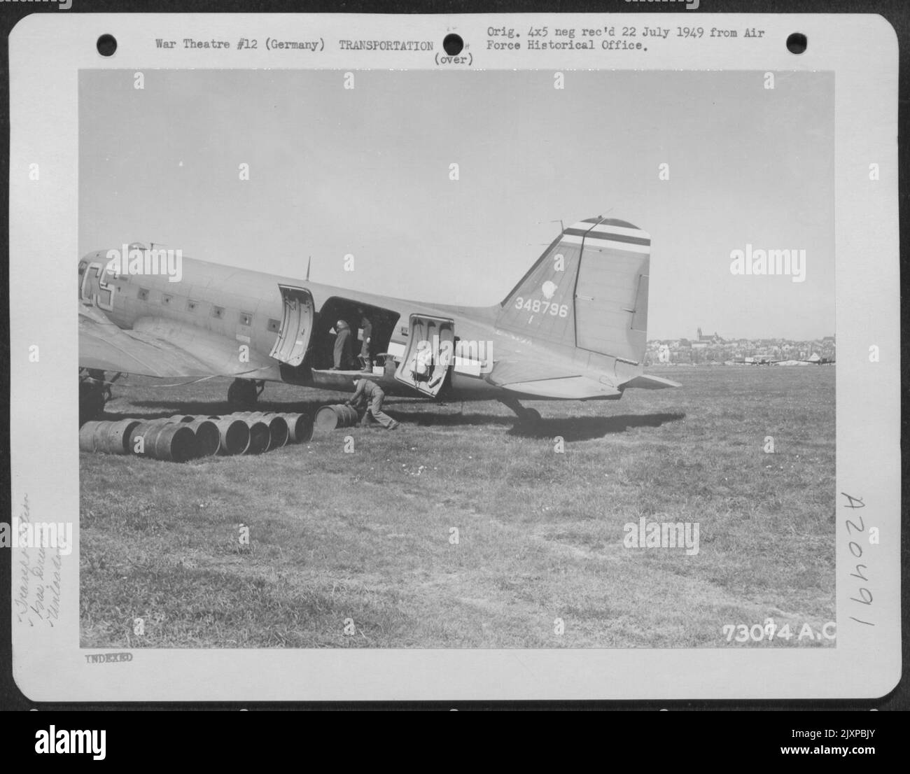 Enlisted Men Unload Gas Cans From A Douglas C-47 At An Airbase ...