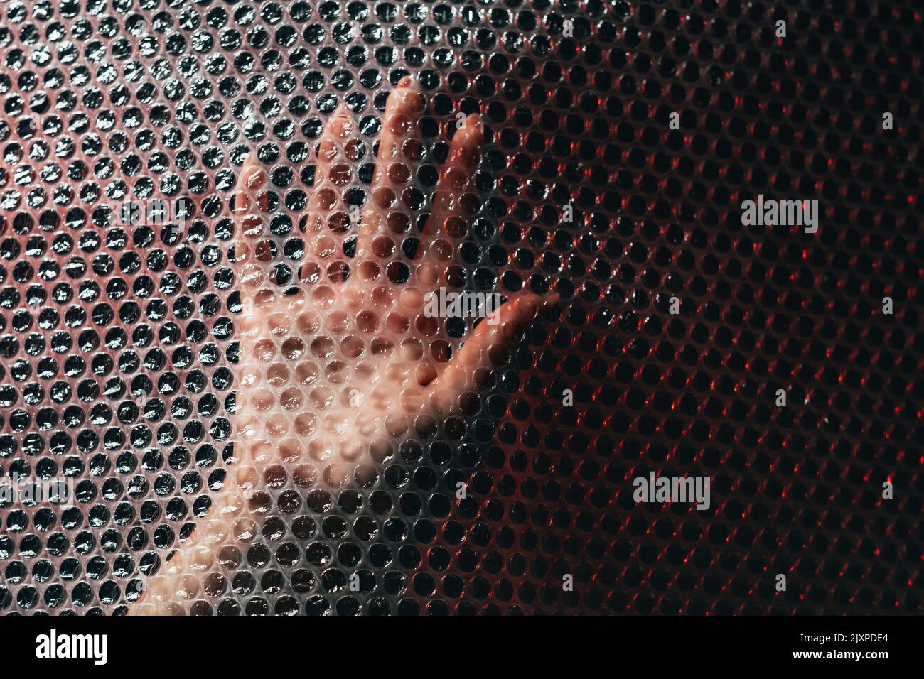 plastic pollution hand bubble wrap texture dark Stock Photo - Alamy