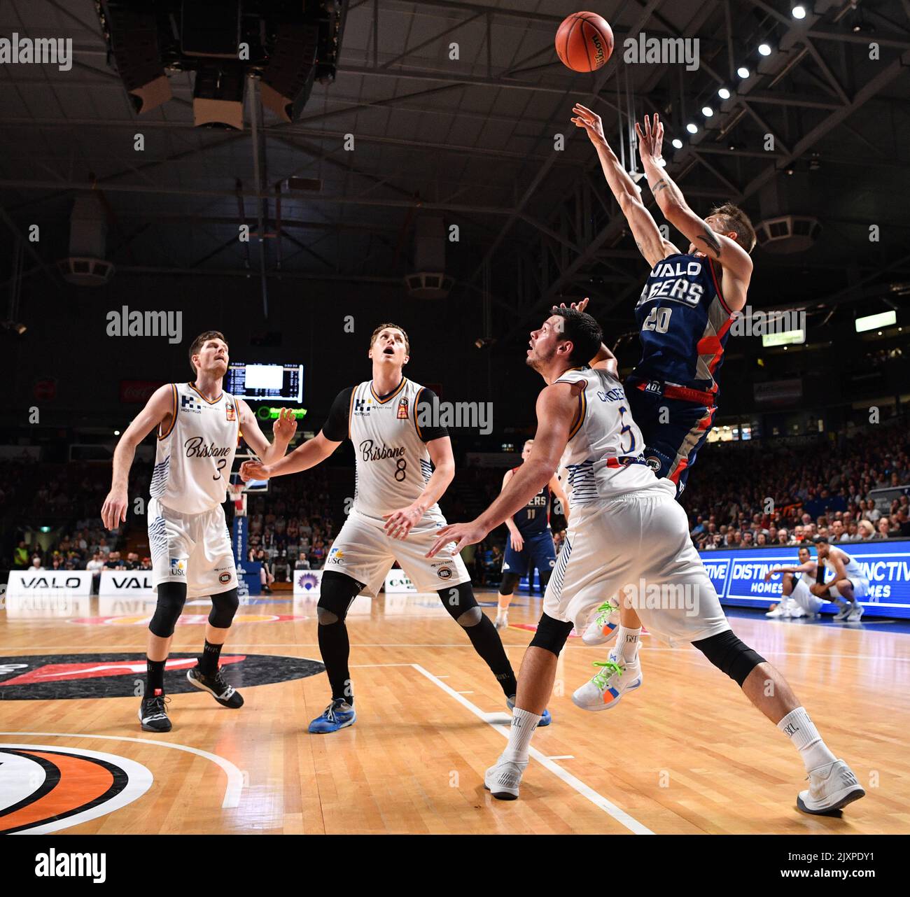 Jason Cadee from the Brisbane Bullets tries to stop Nathan Sobey of the ...