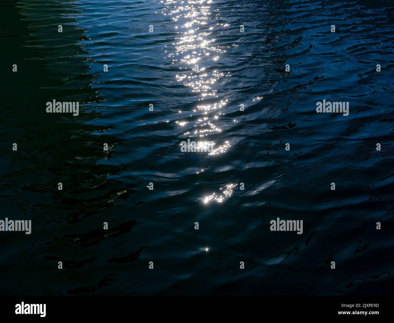 Setting sun falls below the yardarm and casts its long reflection on ...