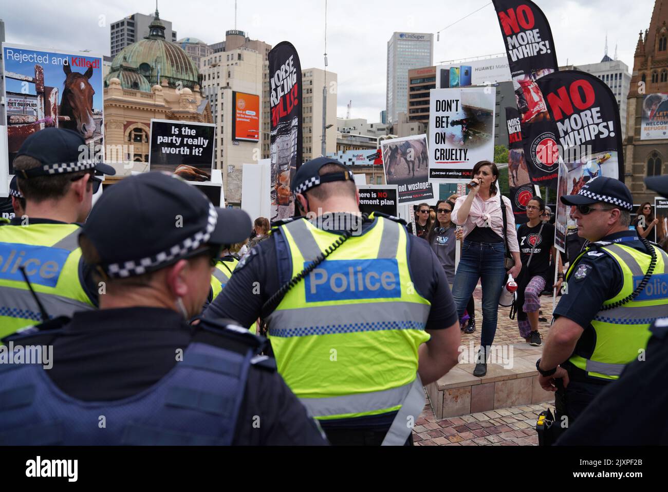 Protestors are seen during the Melbourne Cup parade in Melbourne ...