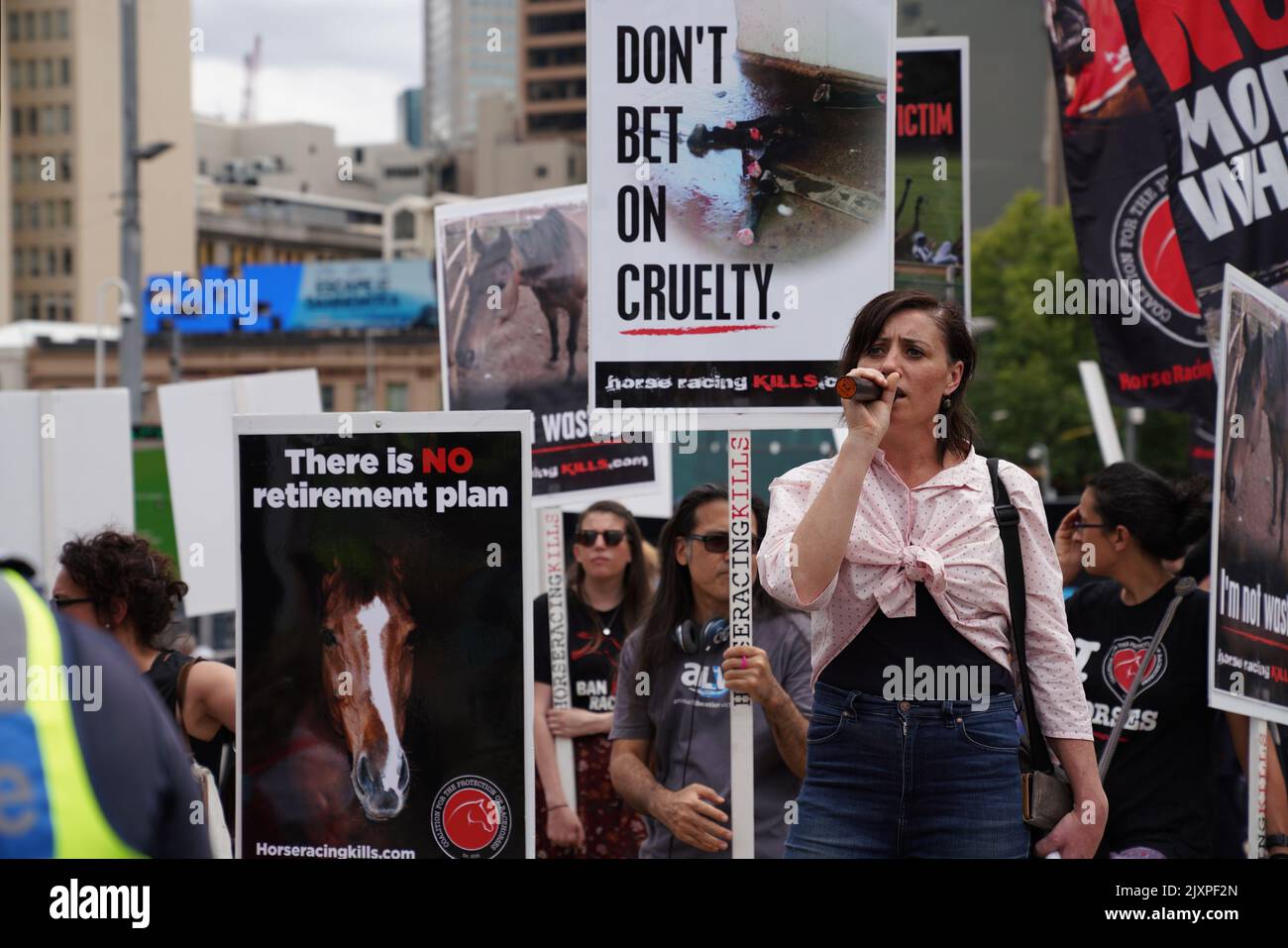 Protestors are seen during the Melbourne Cup parade in Melbourne ...