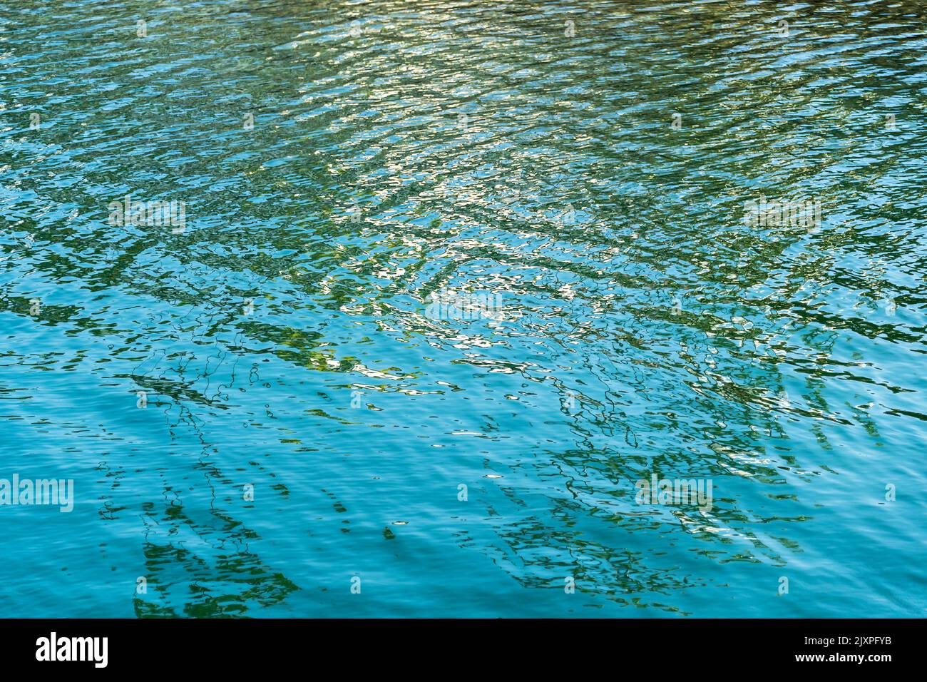 Waterlight reflections ripple and weave on crossing boat wakes Stock ...